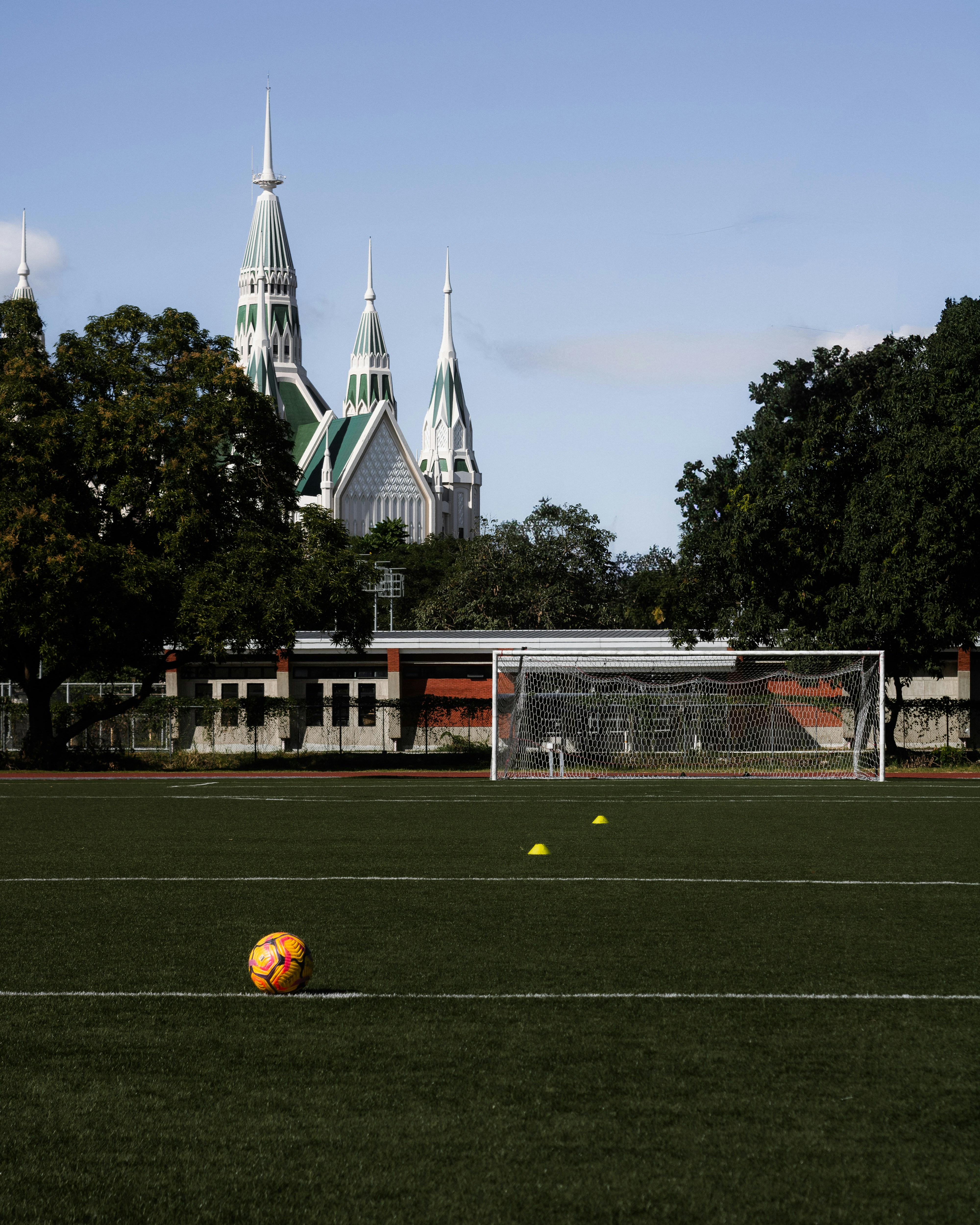 Ground-Level Focus: Soccer Ball Beneath Cathedral Spires