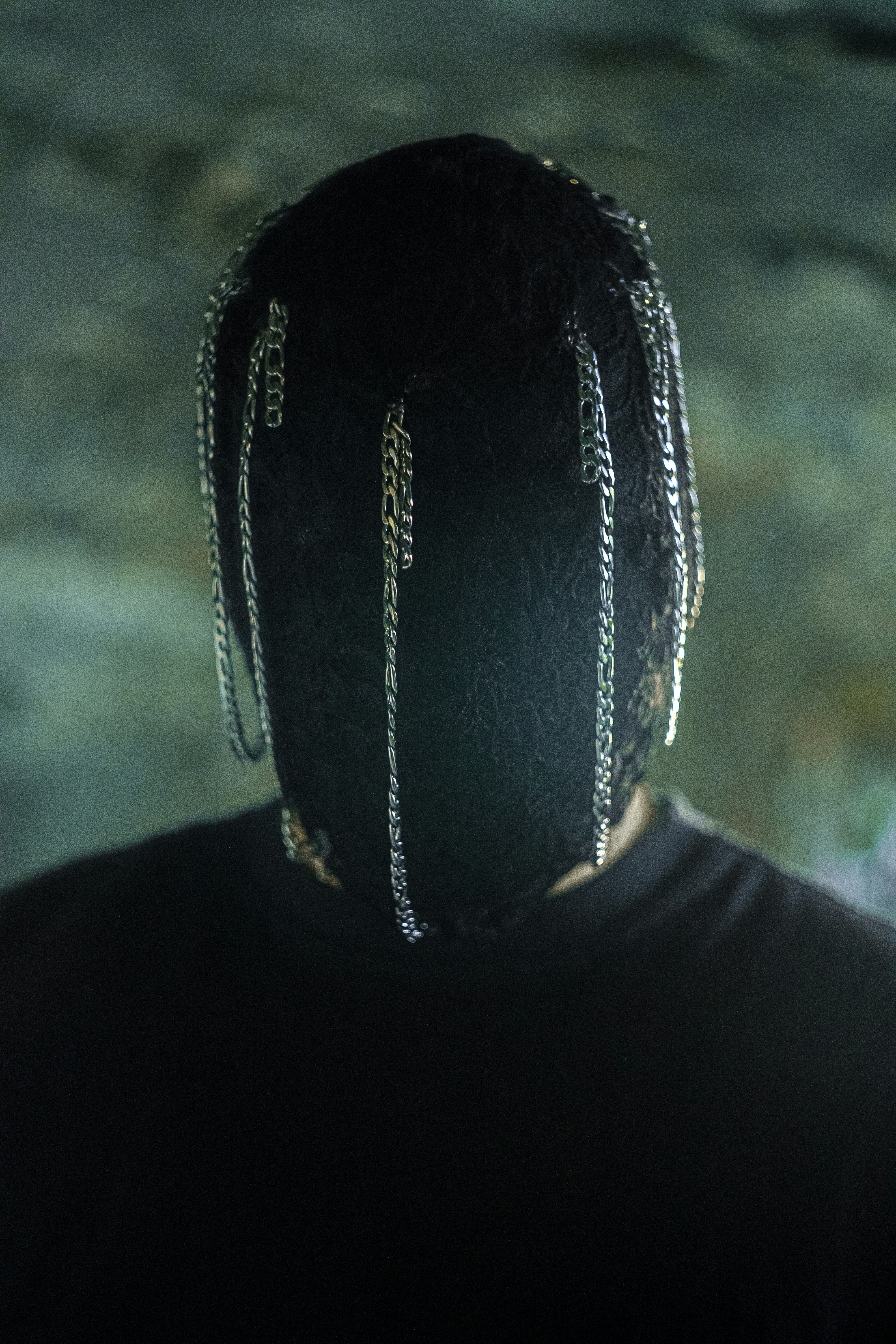 Chains of Silence: A Silhouetted Figure in Verdant Light