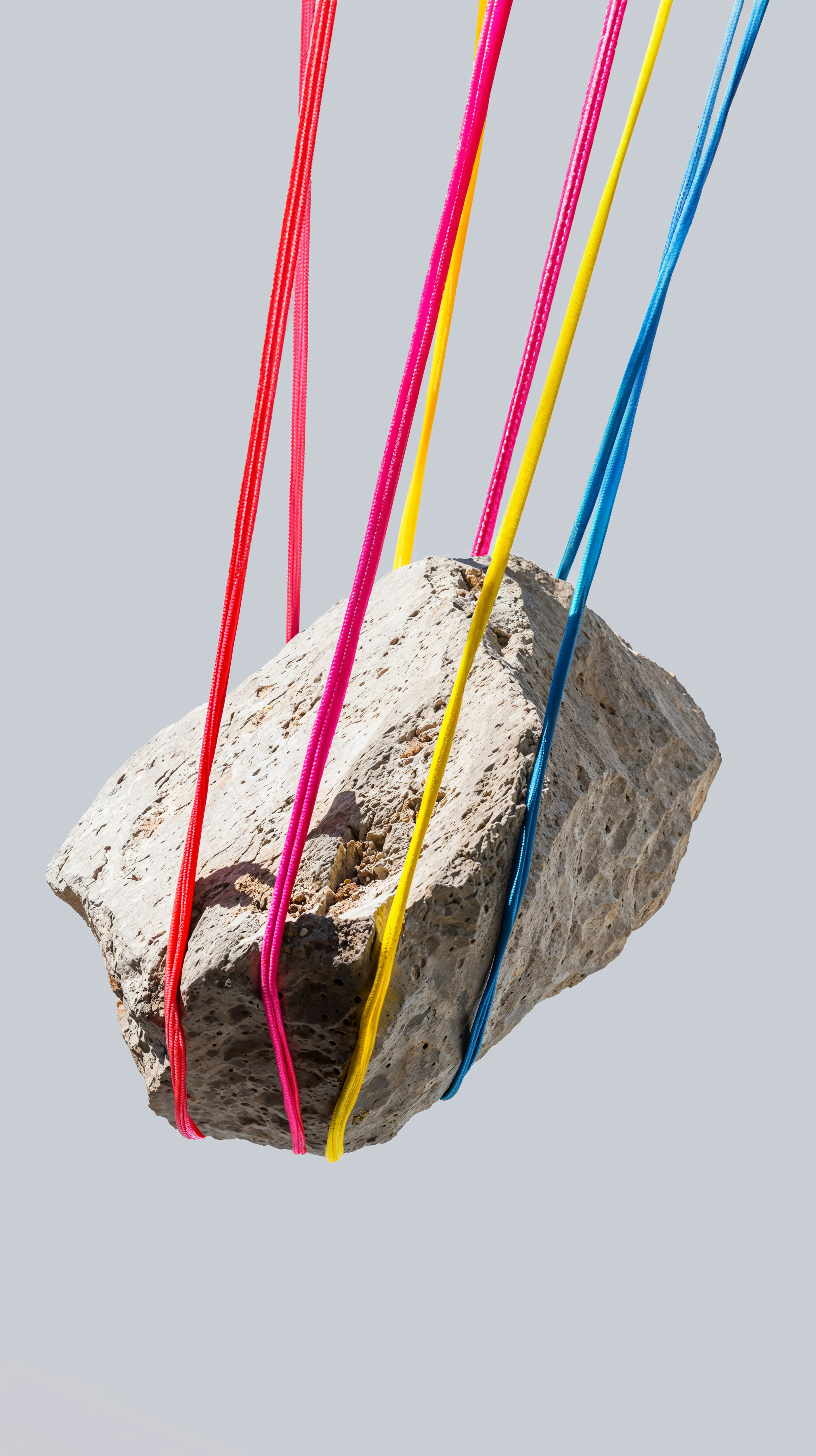 A rock is suspended by colorful strings. photo – Free Wallpaper 4k ...