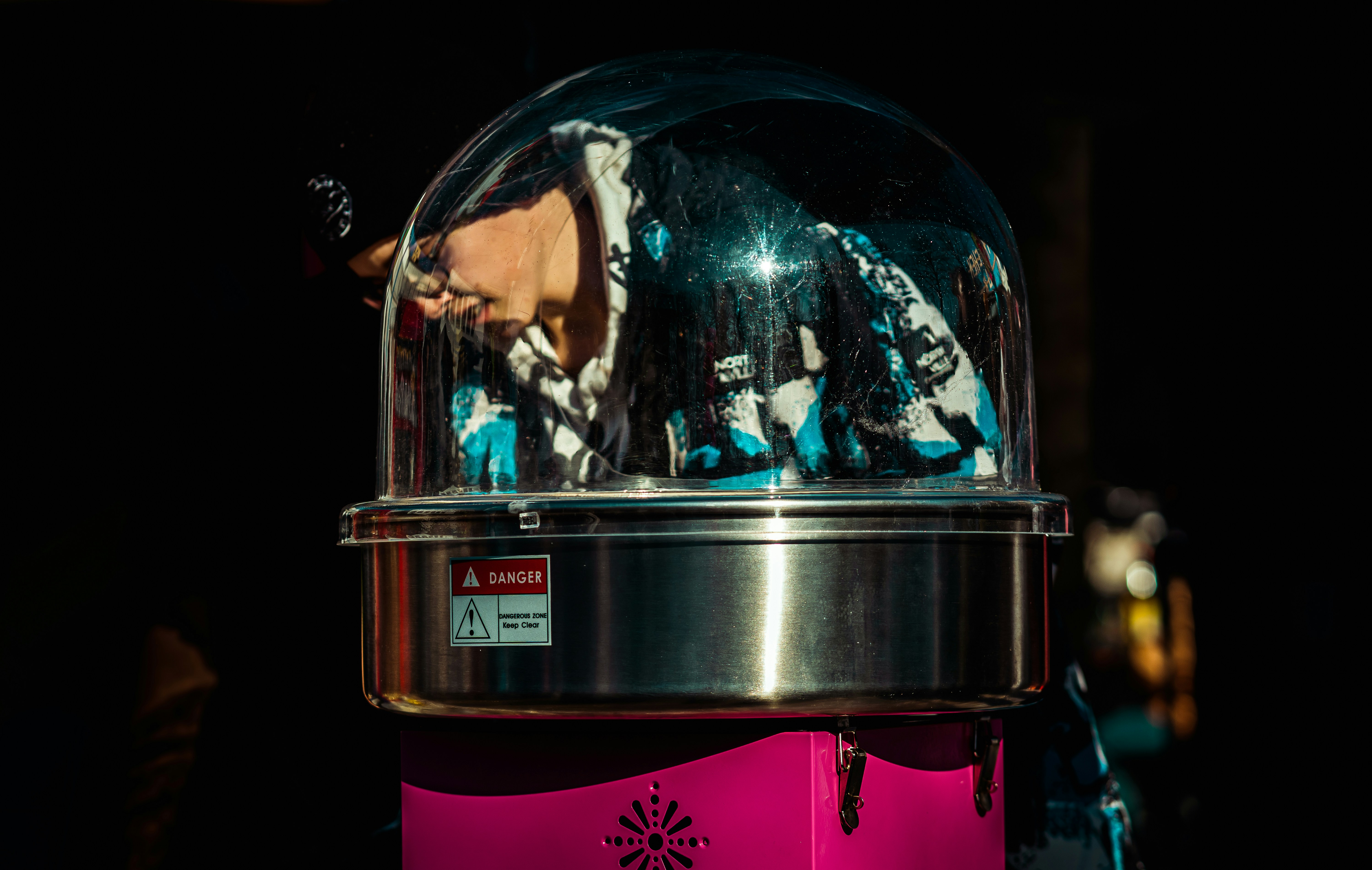 Glass Snow Globe on a Neon-Pink Pedestal in a Dimly Lit Night Scene