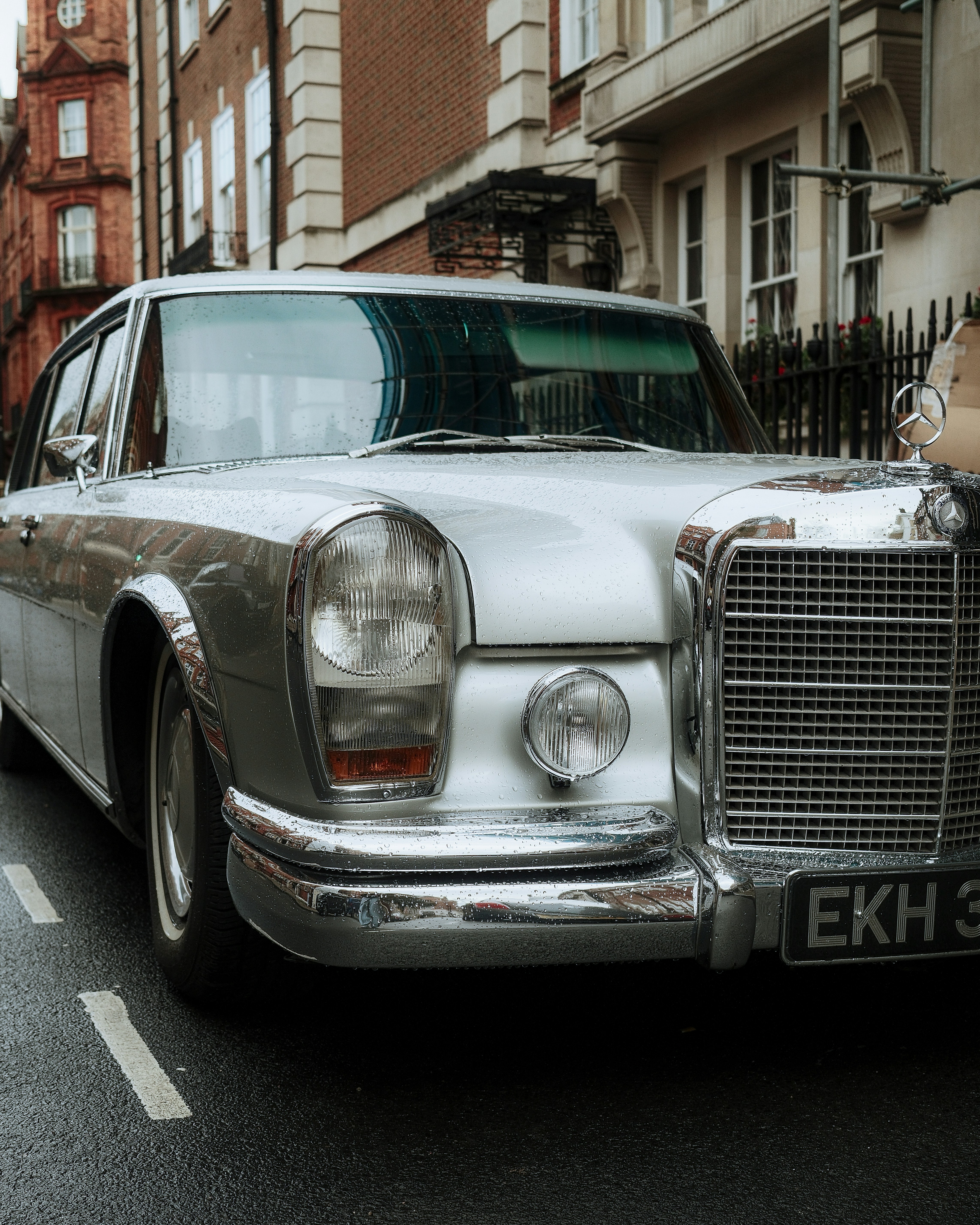Chrome Echo on a Rain-Washed Street: Front-Quarter Portrait of a Vintage Mercedes