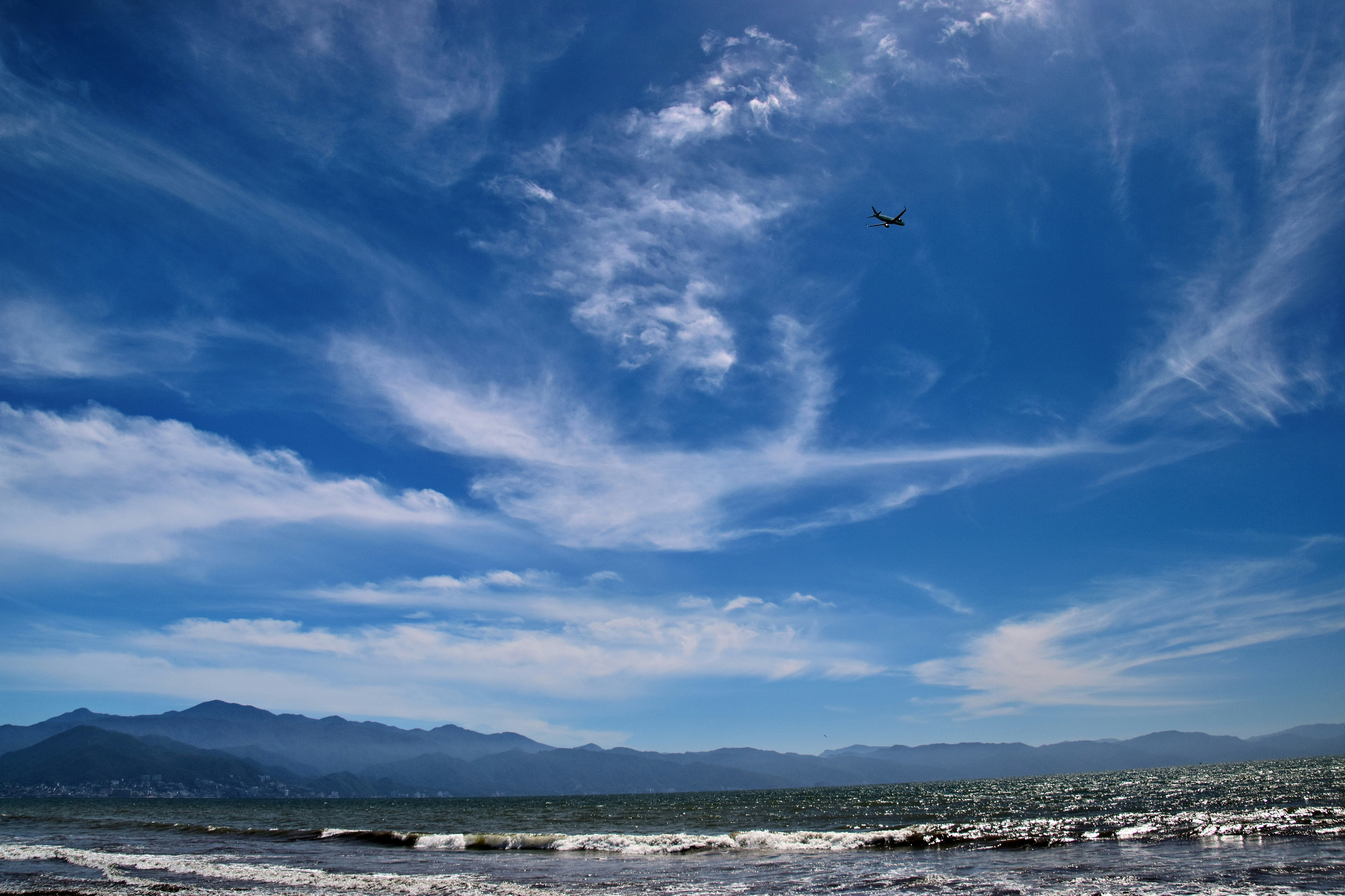 Jet Silhouette Over a Crystalline Coastal Horizon