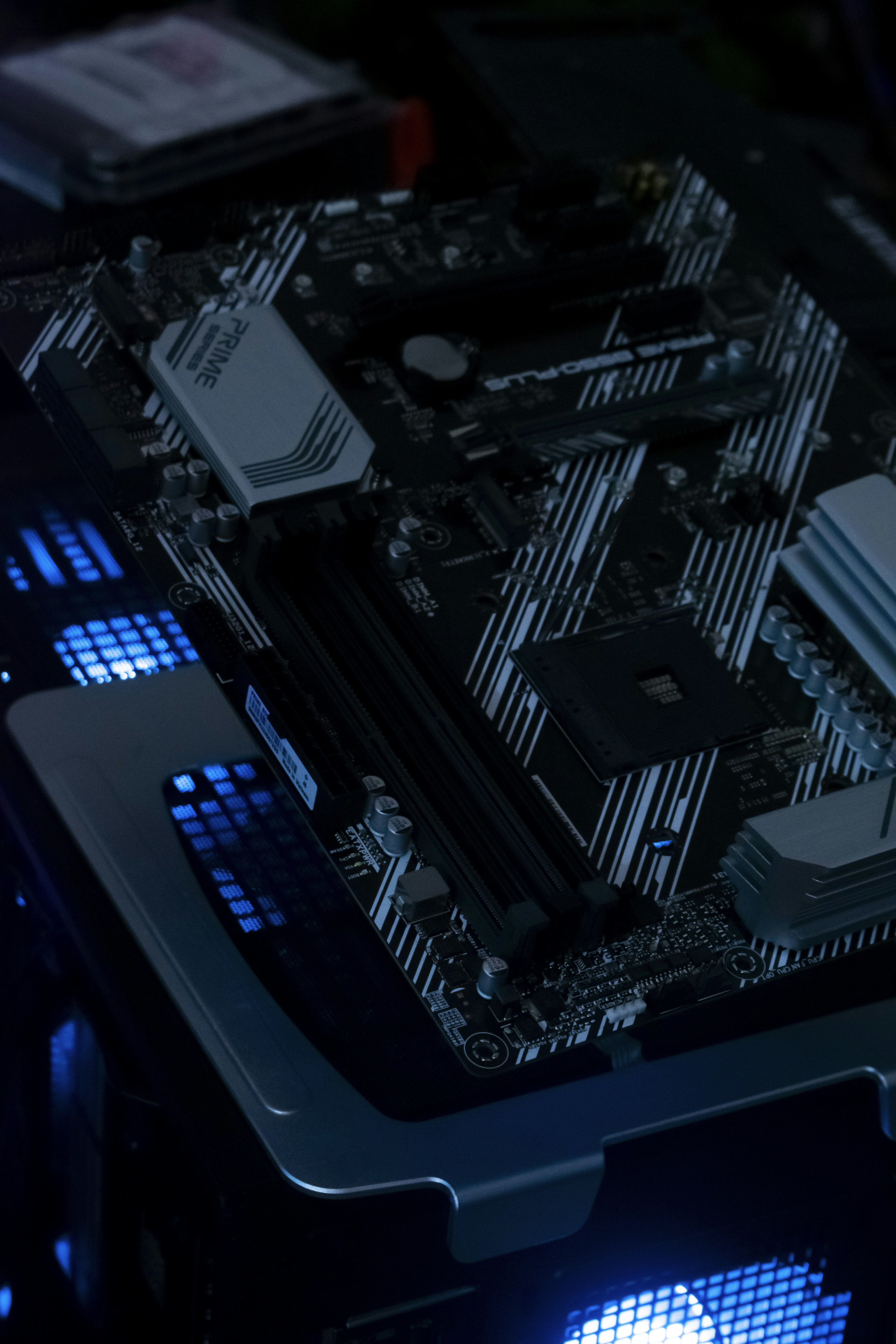 Neon-Circuitry in Focus: a Blue-lit Motherboard Close-Up
