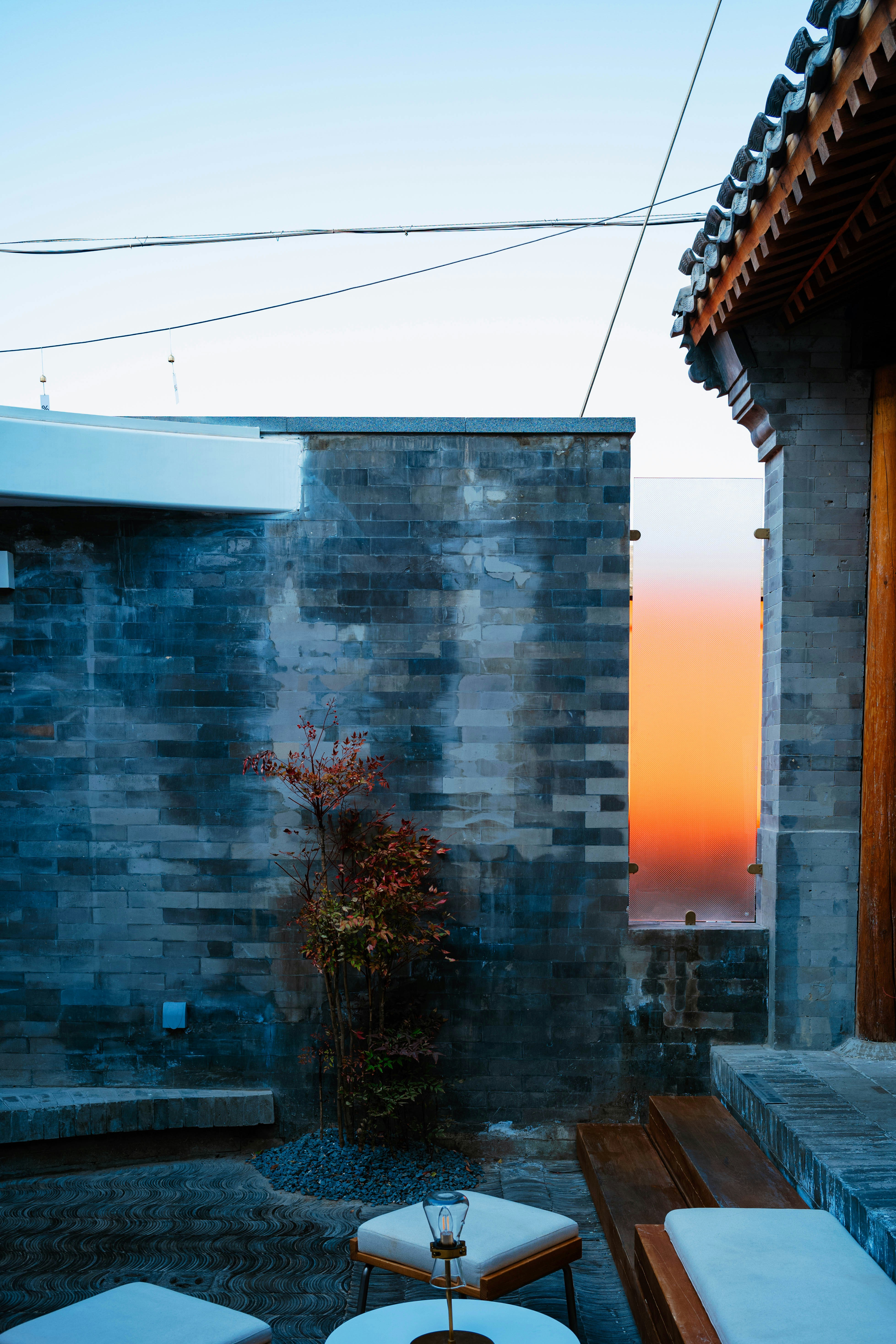 Sunset Window: Narrow Orange View Between Blue Stone Walls