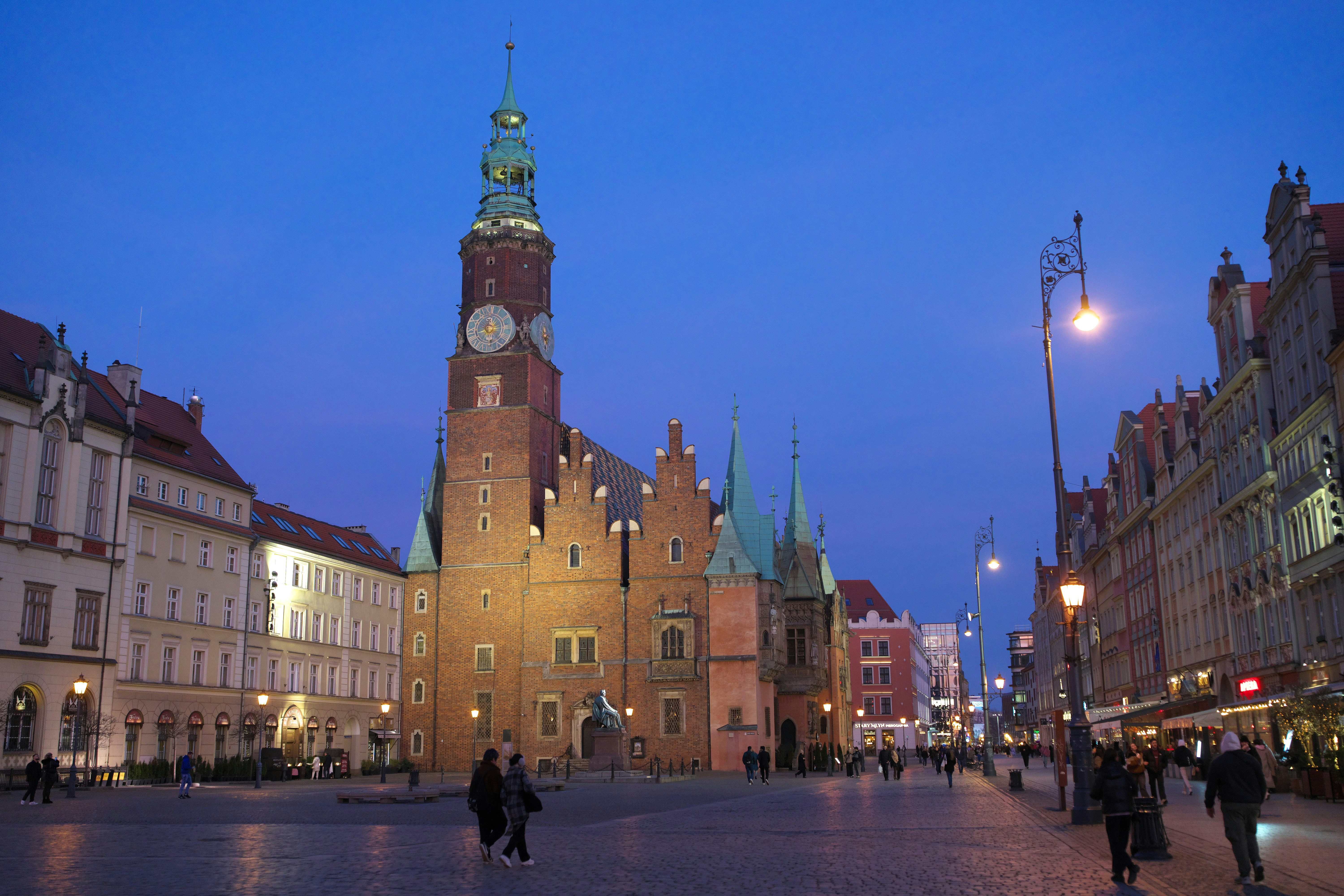 Rynek, Wrocław, Poland | A city square shows a tall clock tower.