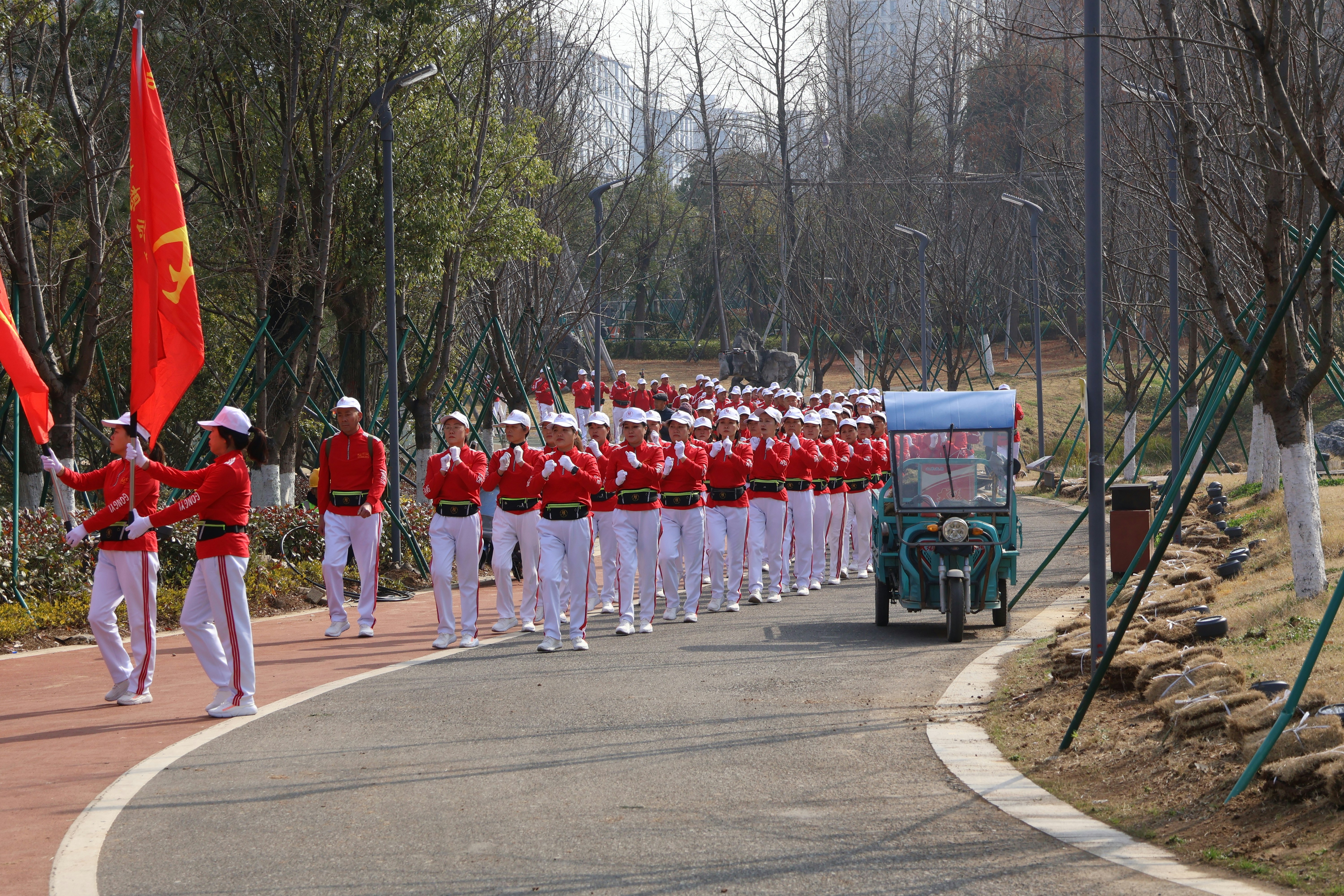 People in red uniforms march with flags. photo – Free Man Image on Unsplash