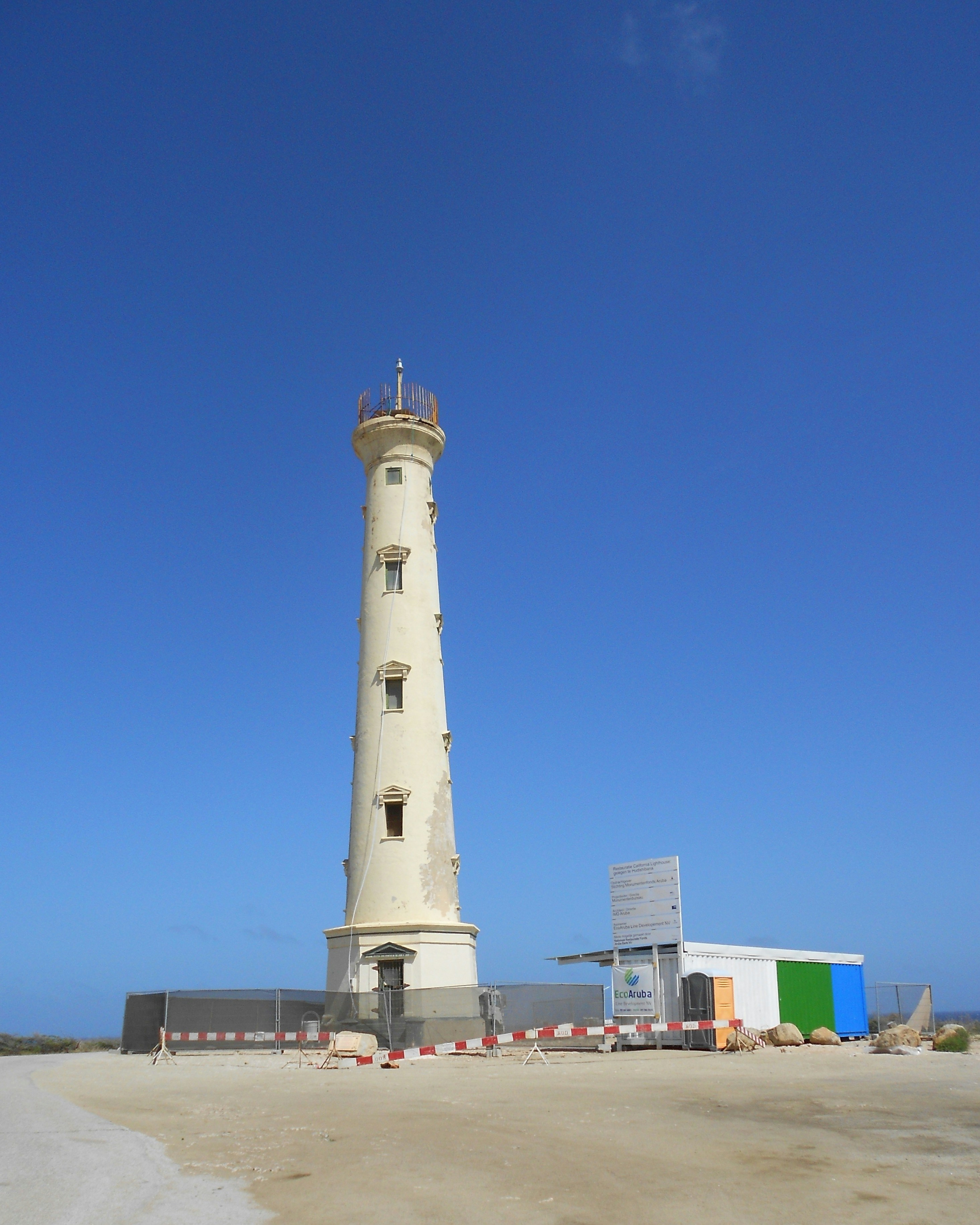 A tall lighthouse stands against a bright blue sky. photo – Free ...