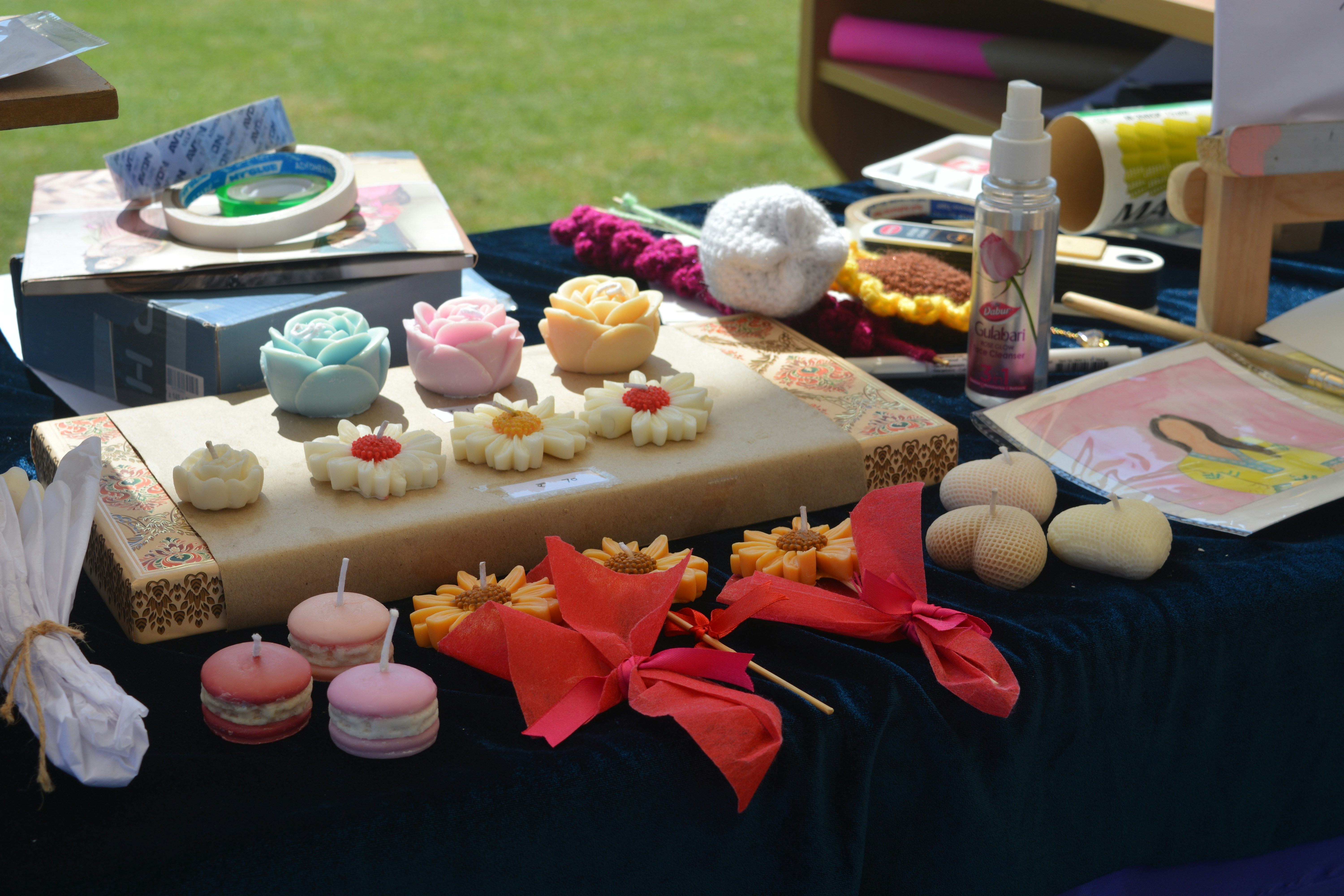 Pastel Soap Blossoms and Craft Trinkets on a Sunlit Vendor Table