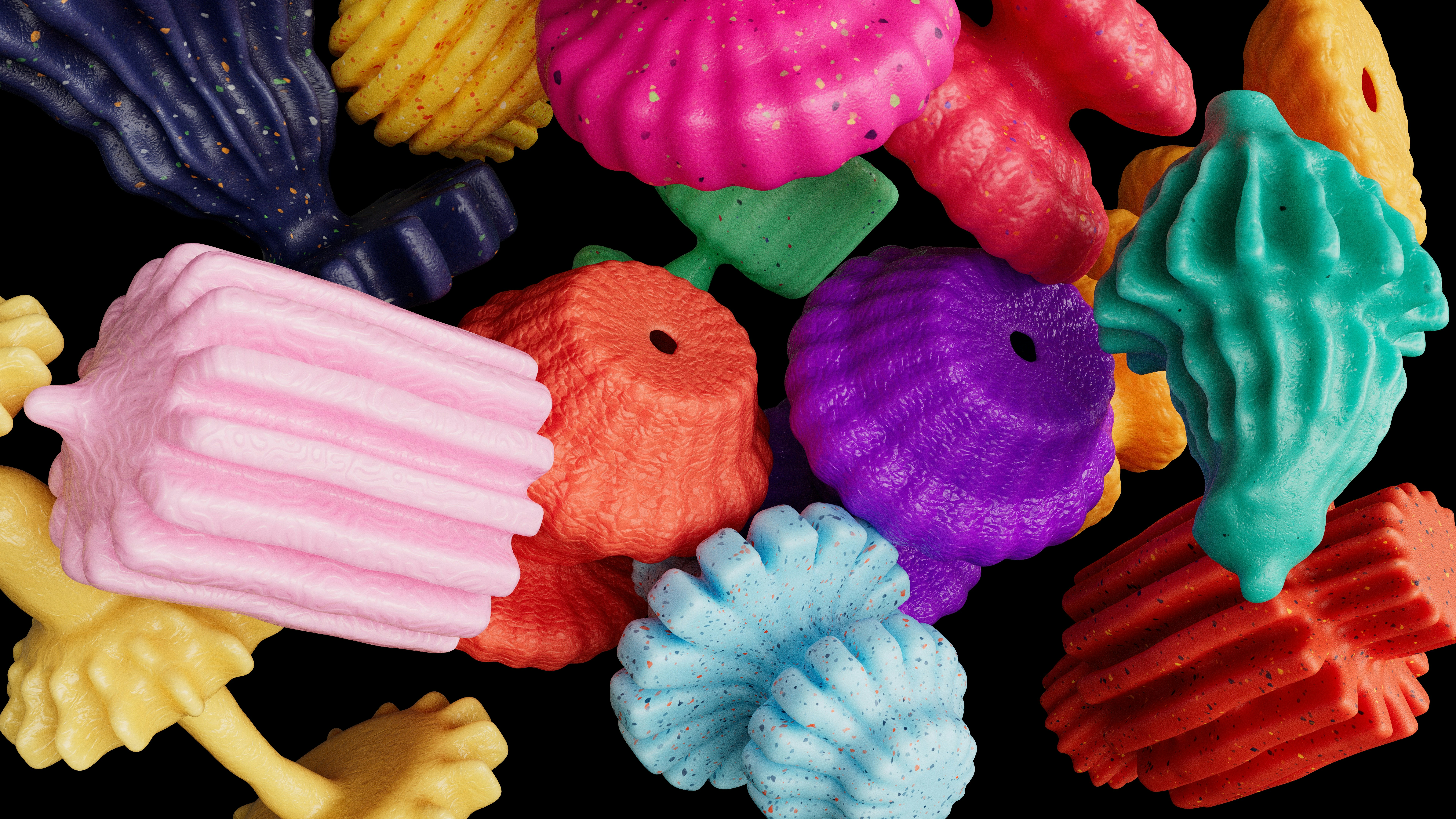 Colorful plastic shapes scattered against a dark background. photo ...