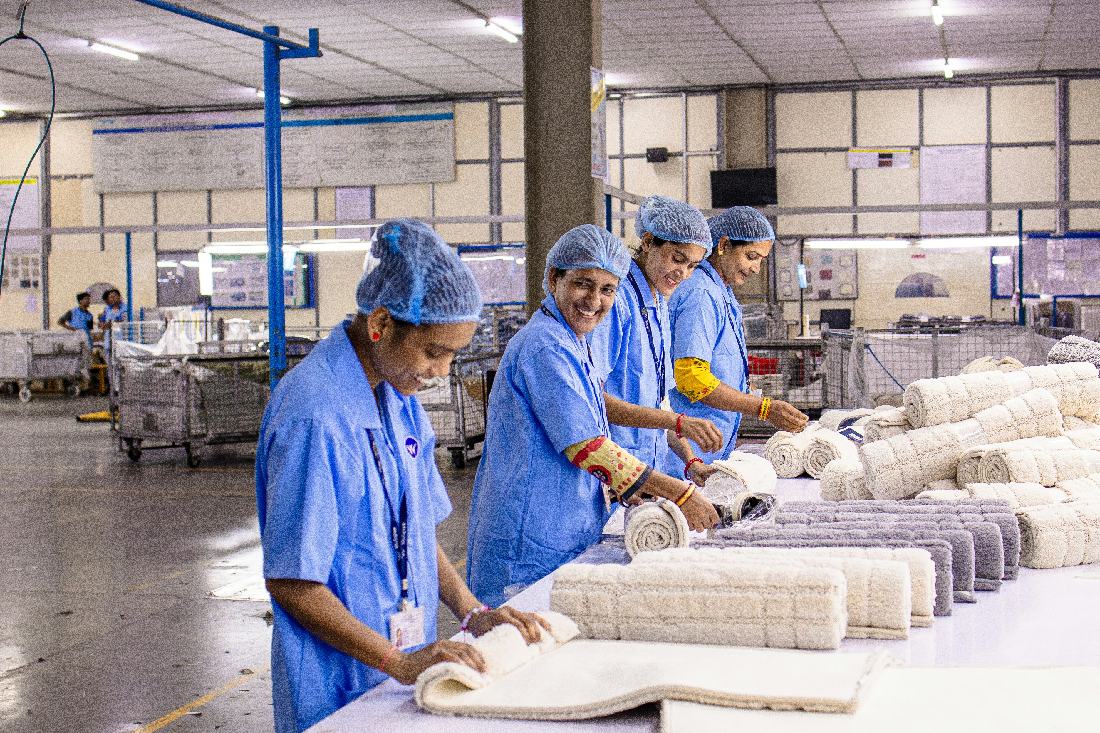 Workers sort and roll textiles in a factory. photo – Free Worker Image ...