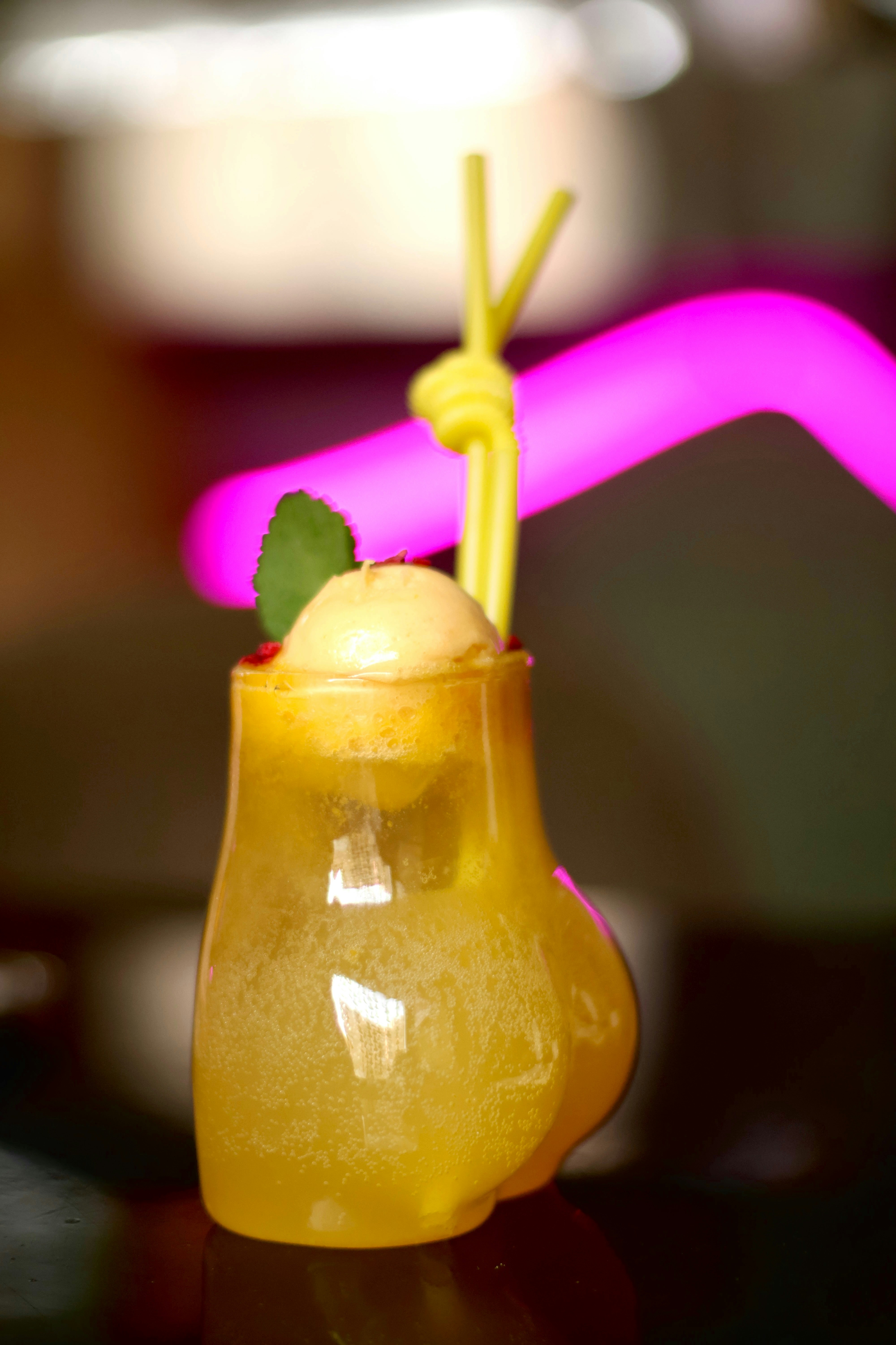 Neon Citrus: A Curved-Glass Cocktail Under Pink Glow