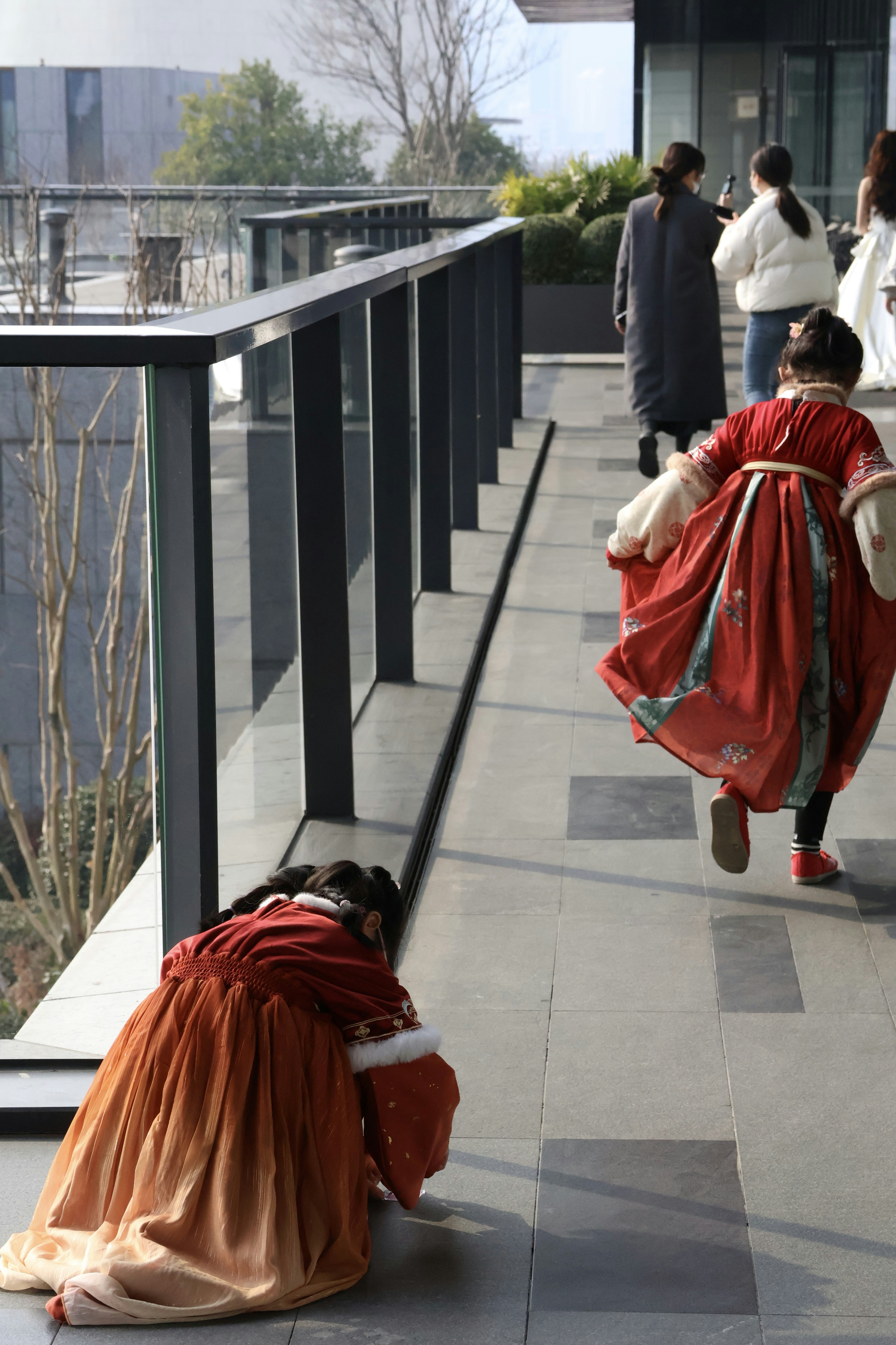 Red Hanbok in Motion Along a Glass-Walled Terrace