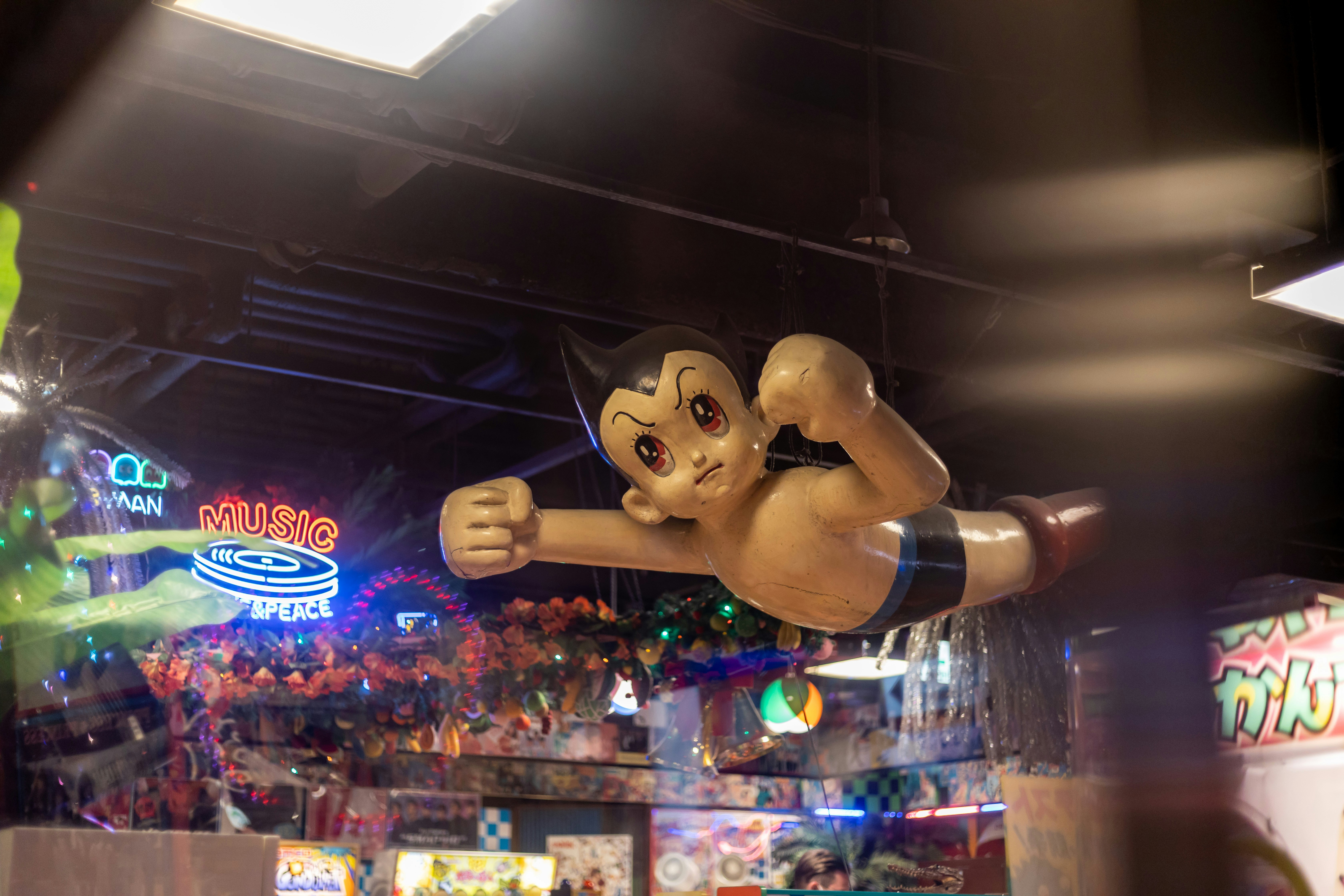 Neon Arcade Hero: Hovering Cartoon Figure Above the Game Floor