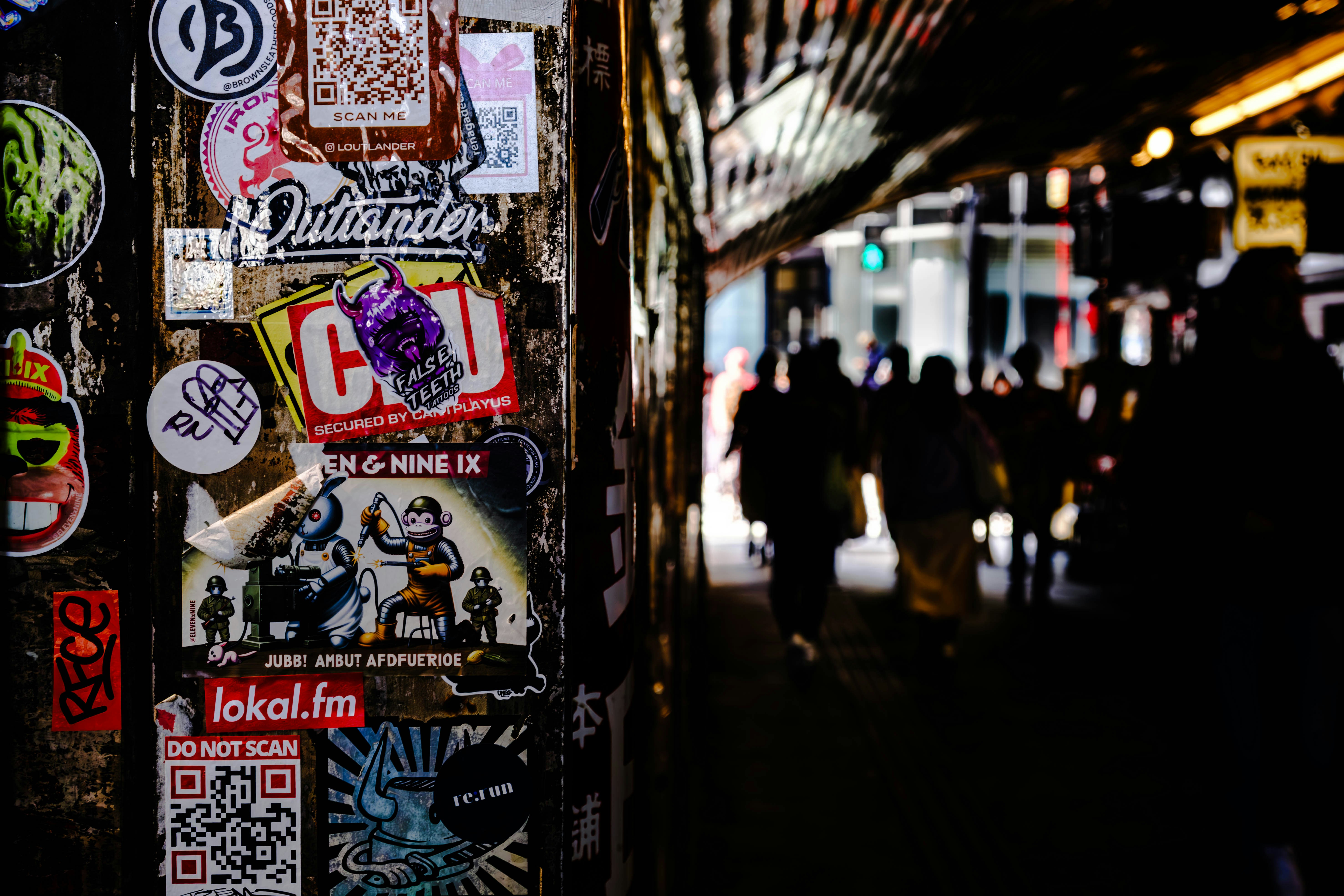 Street scene features a column covered with stickers. photo – Free City ...