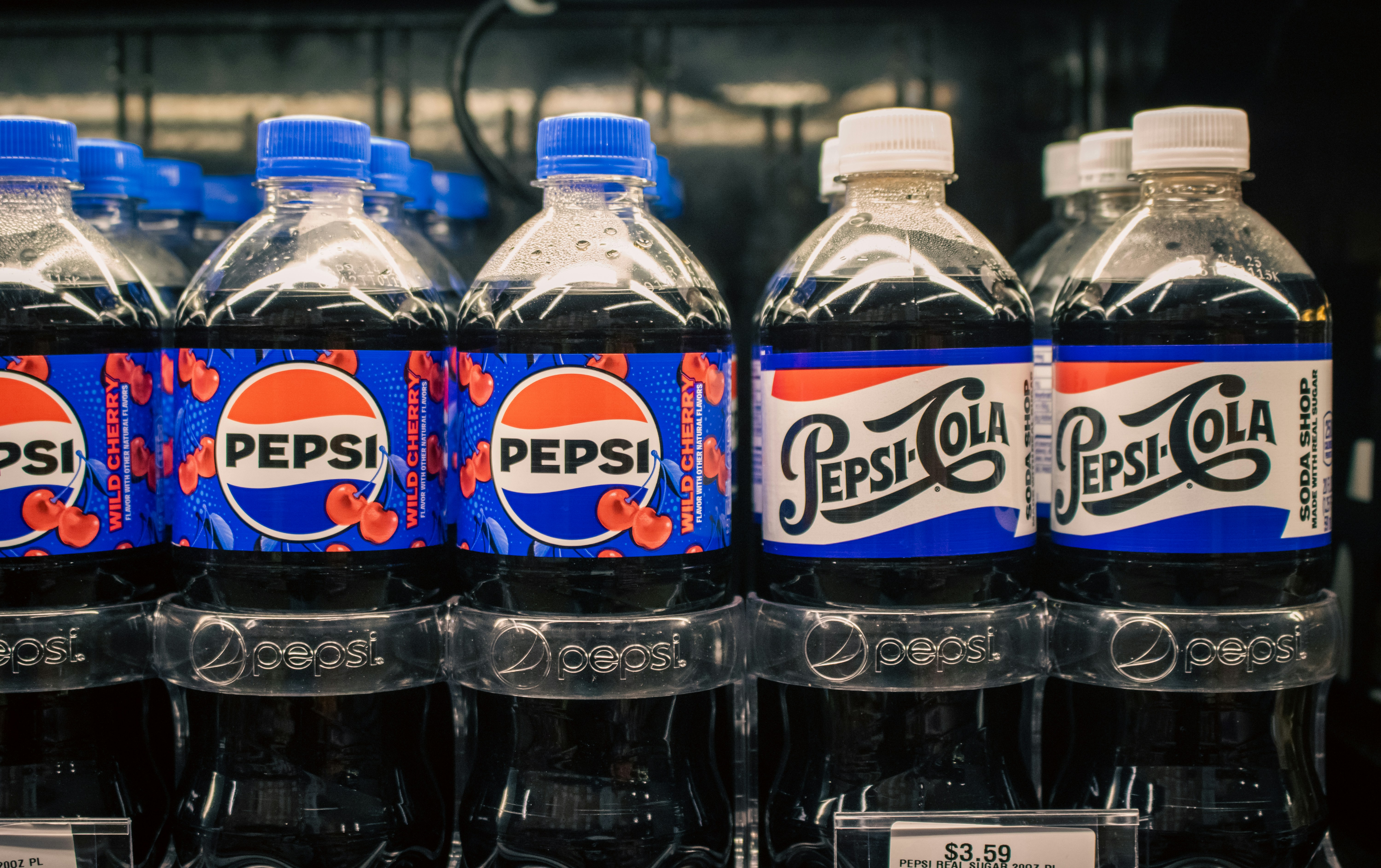 Pepsi bottles lined up on a store shelf. photo – Free Drinks Image on ...