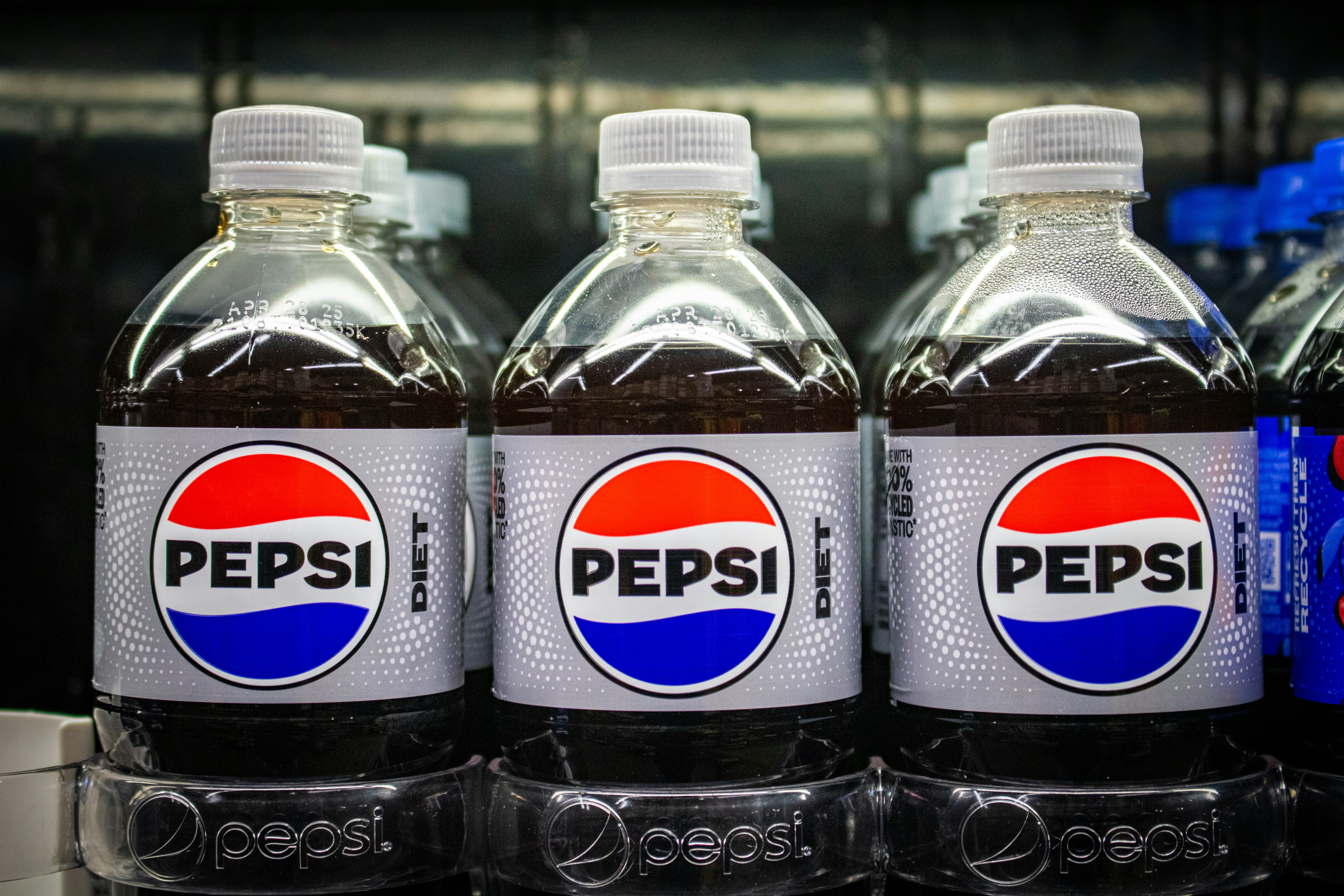 Uniform Bottles: A Row of Pepsi Labels on a Store Shelf