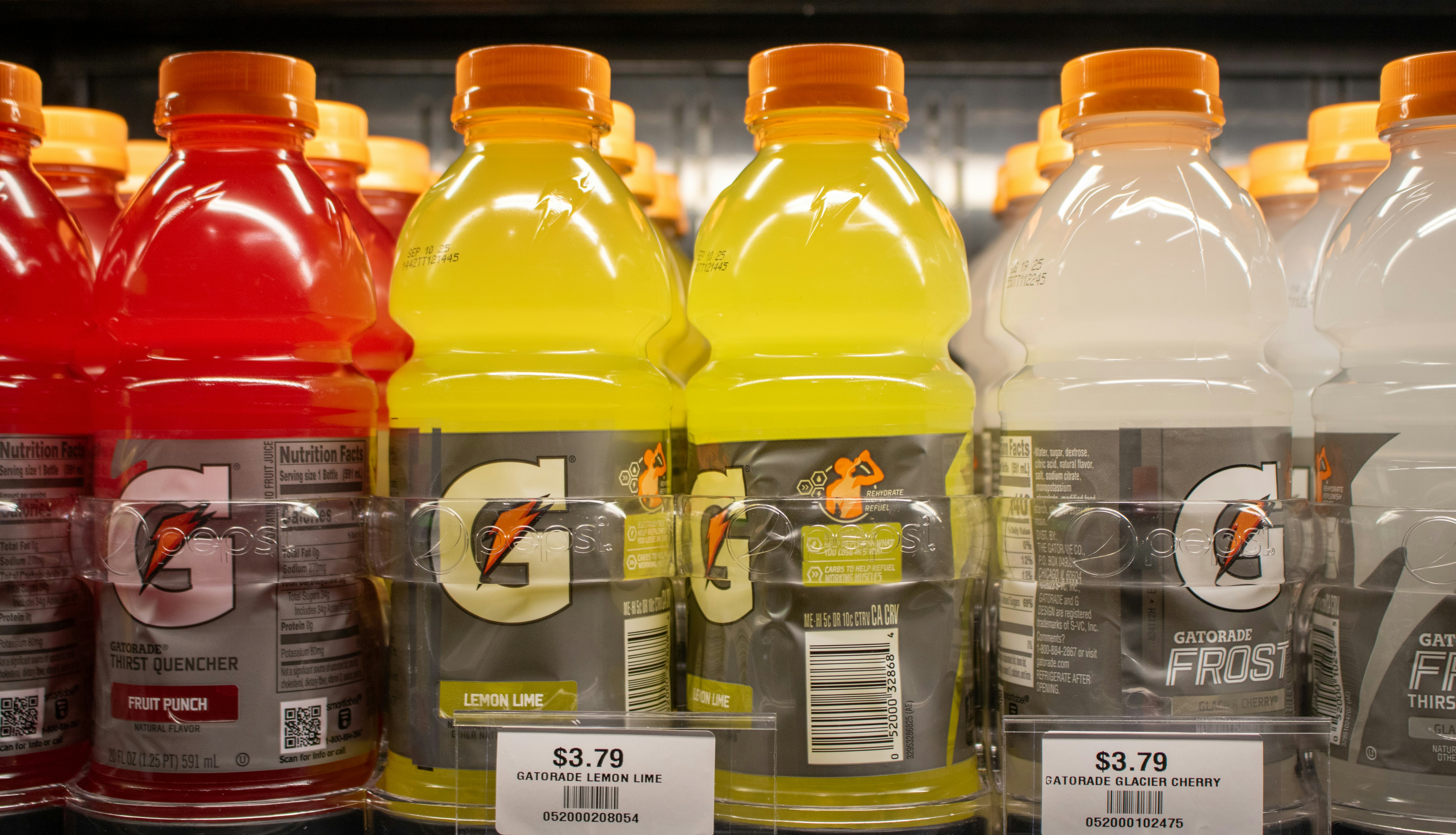 Gatorade bottles are neatly displayed on a shelf. photo – Free Food ...
