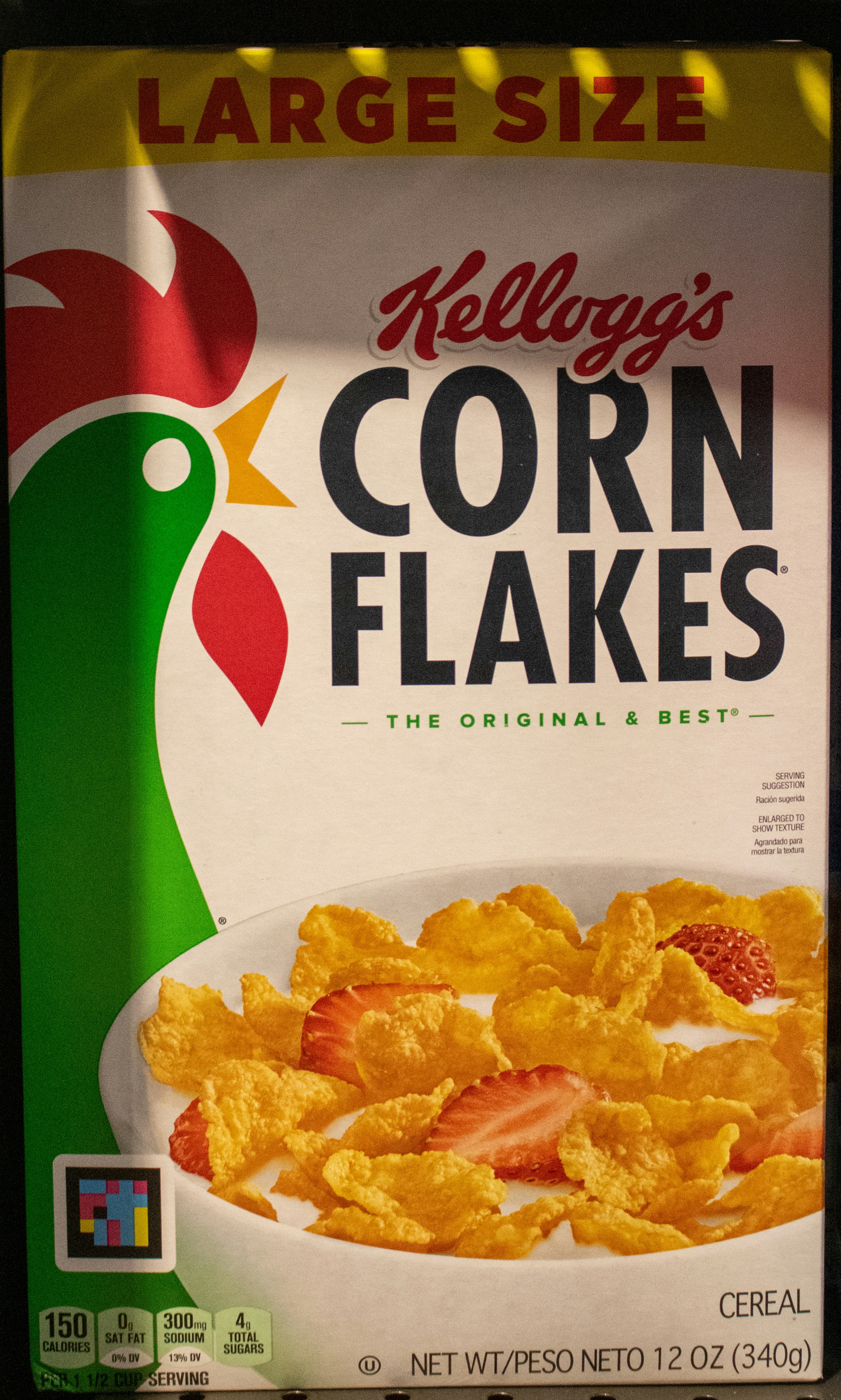 Kellogg's Corn Flakes box featuring a vibrant rooster logo and a bowl of cereal with strawberries. Perfect for a wholesome breakfast.