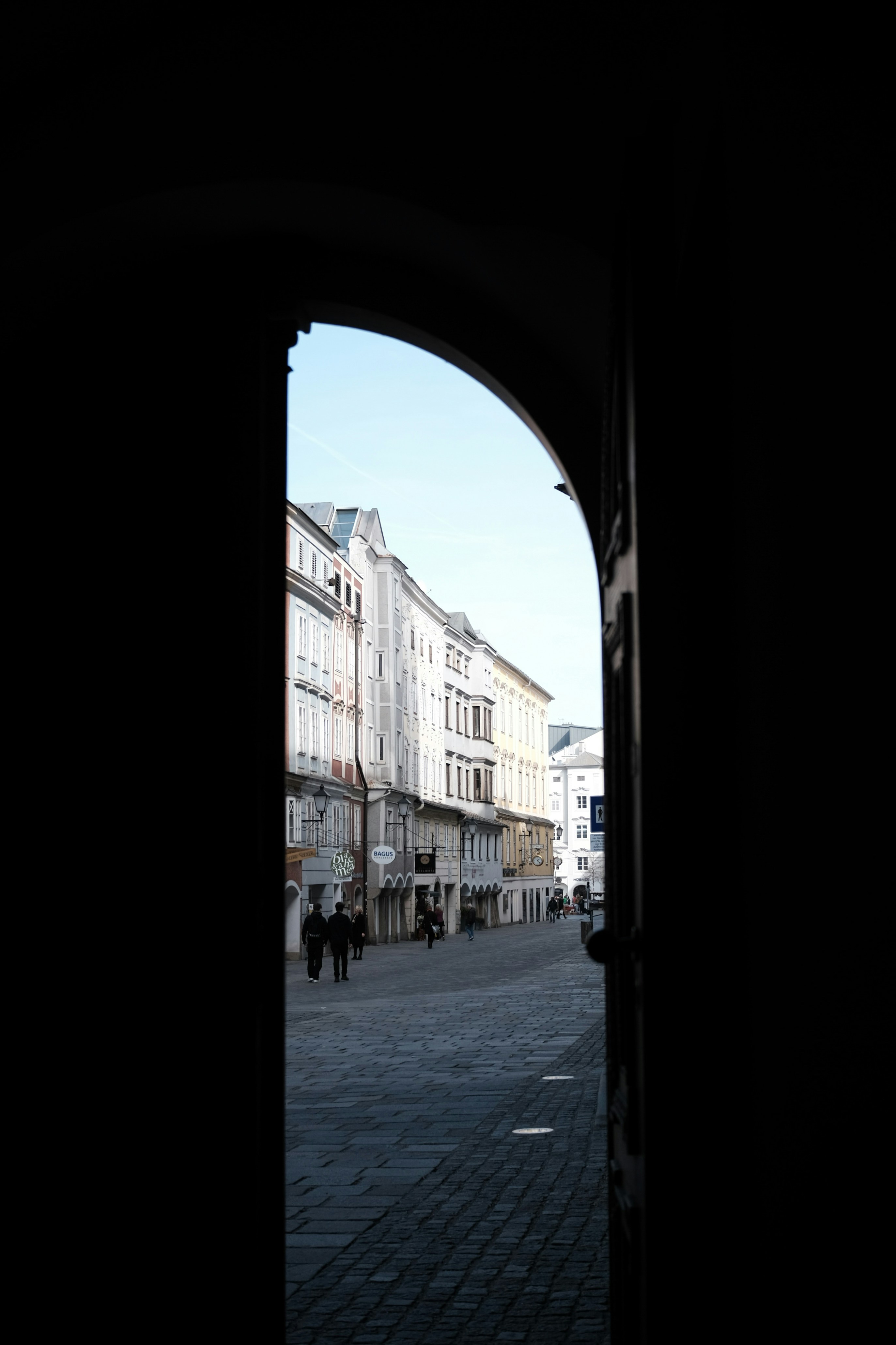View of a street framed by an archway.