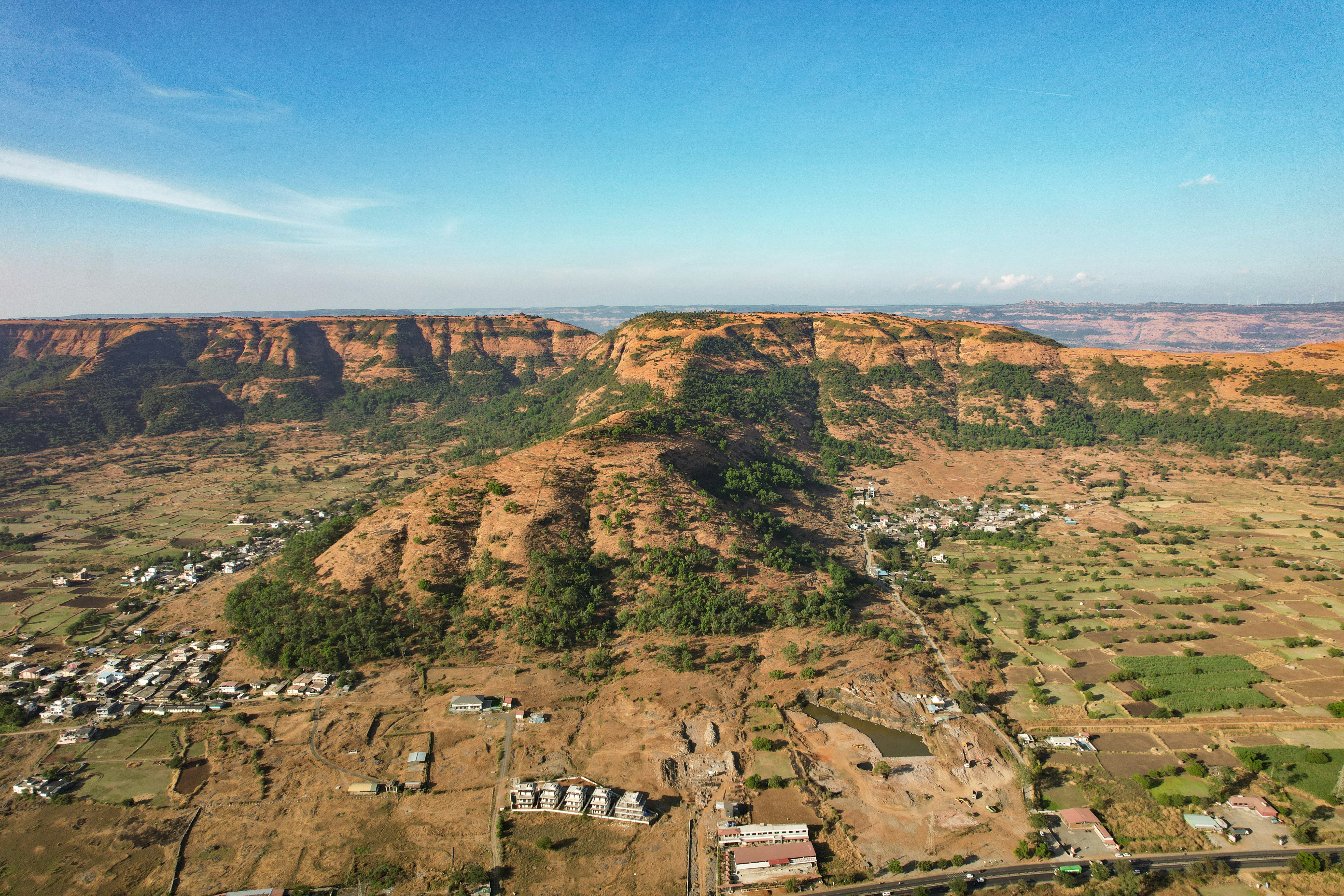 Sunlit Mesas Over a Patchwork Desert Town