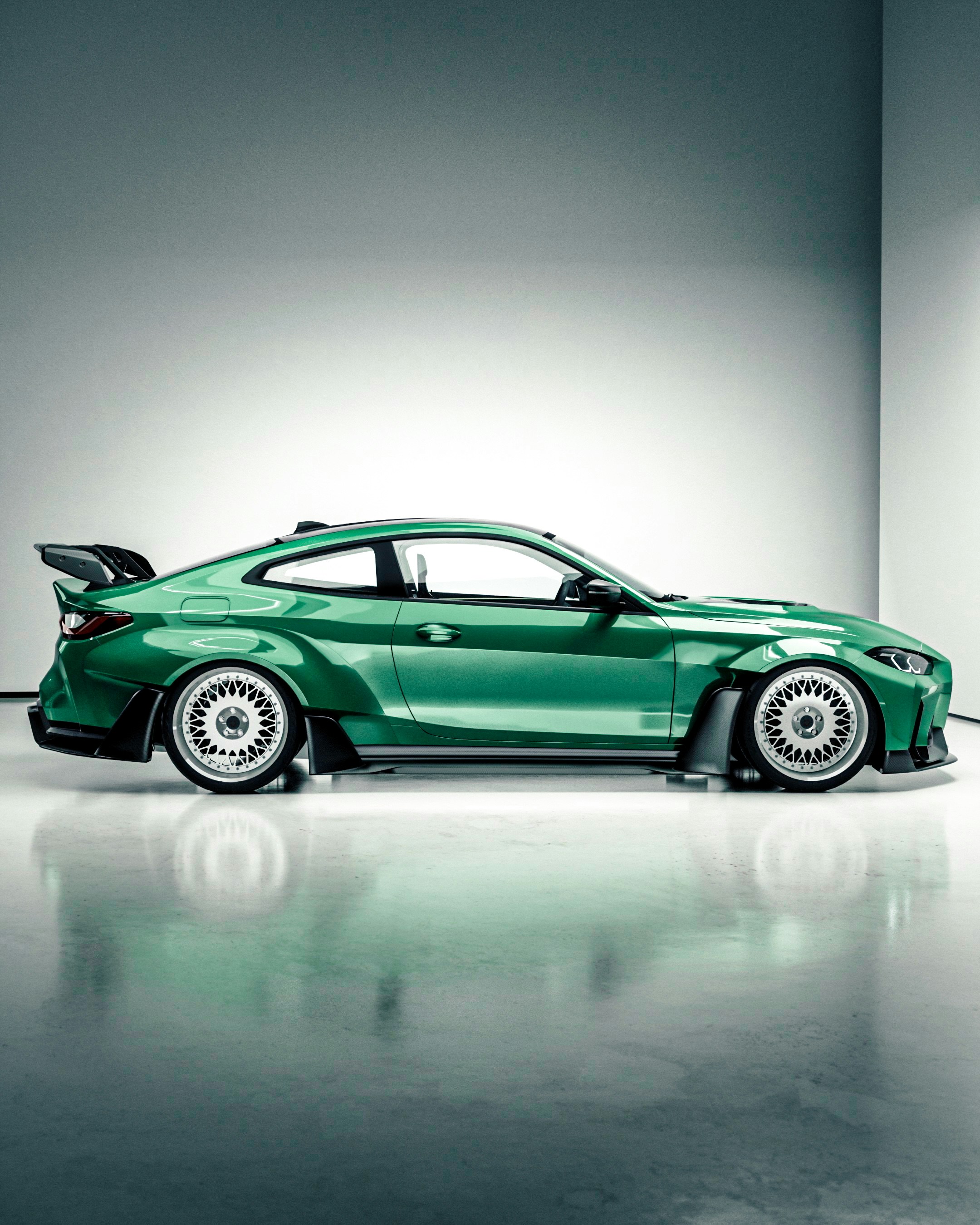 A green, modified BMW car in a studio. photo – Free Car Image on Unsplash