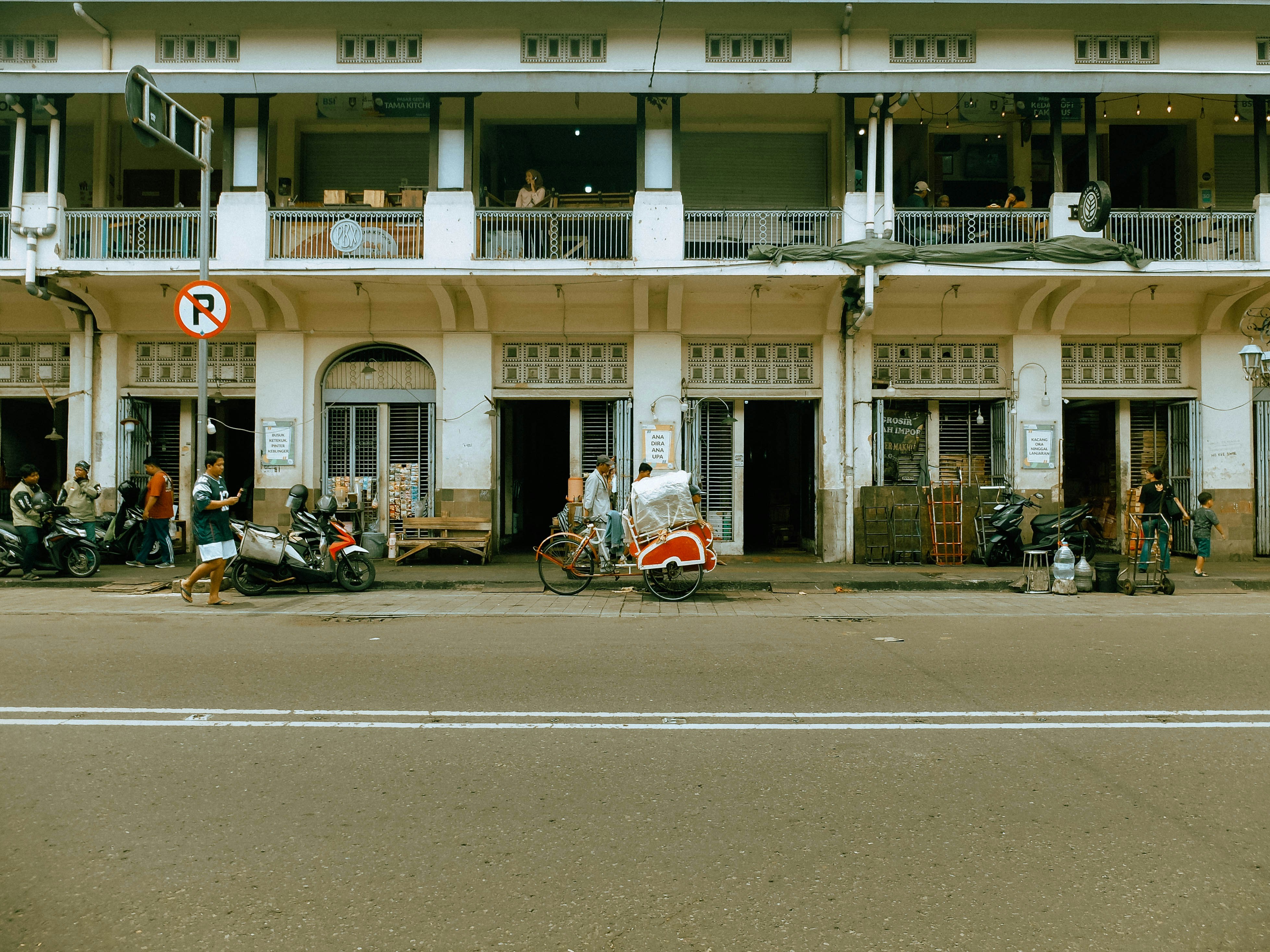 Historic building facade with street vendors and pedestrians.