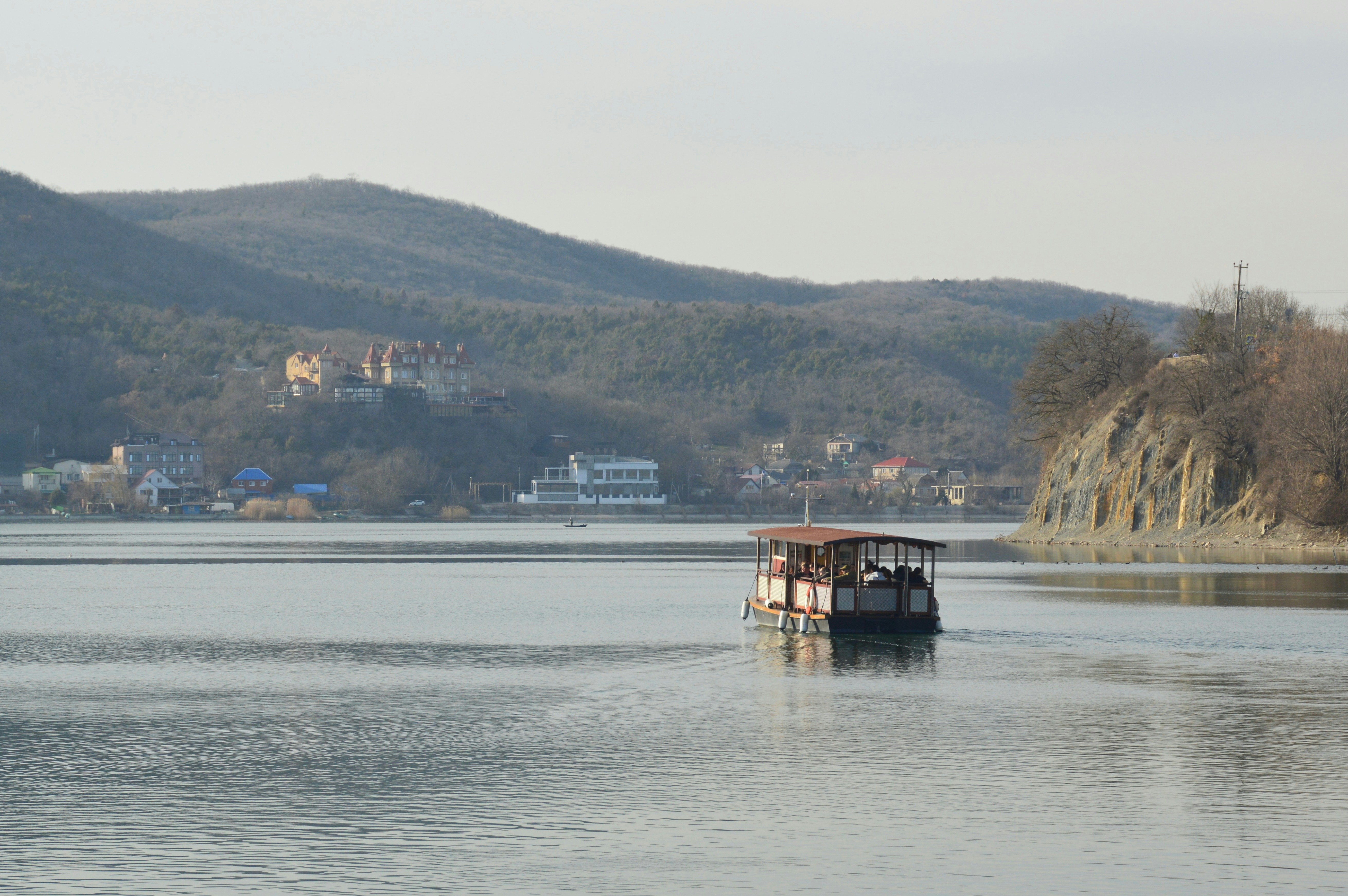 Quiet Boat on a Serene Lake Under Gentle Hills