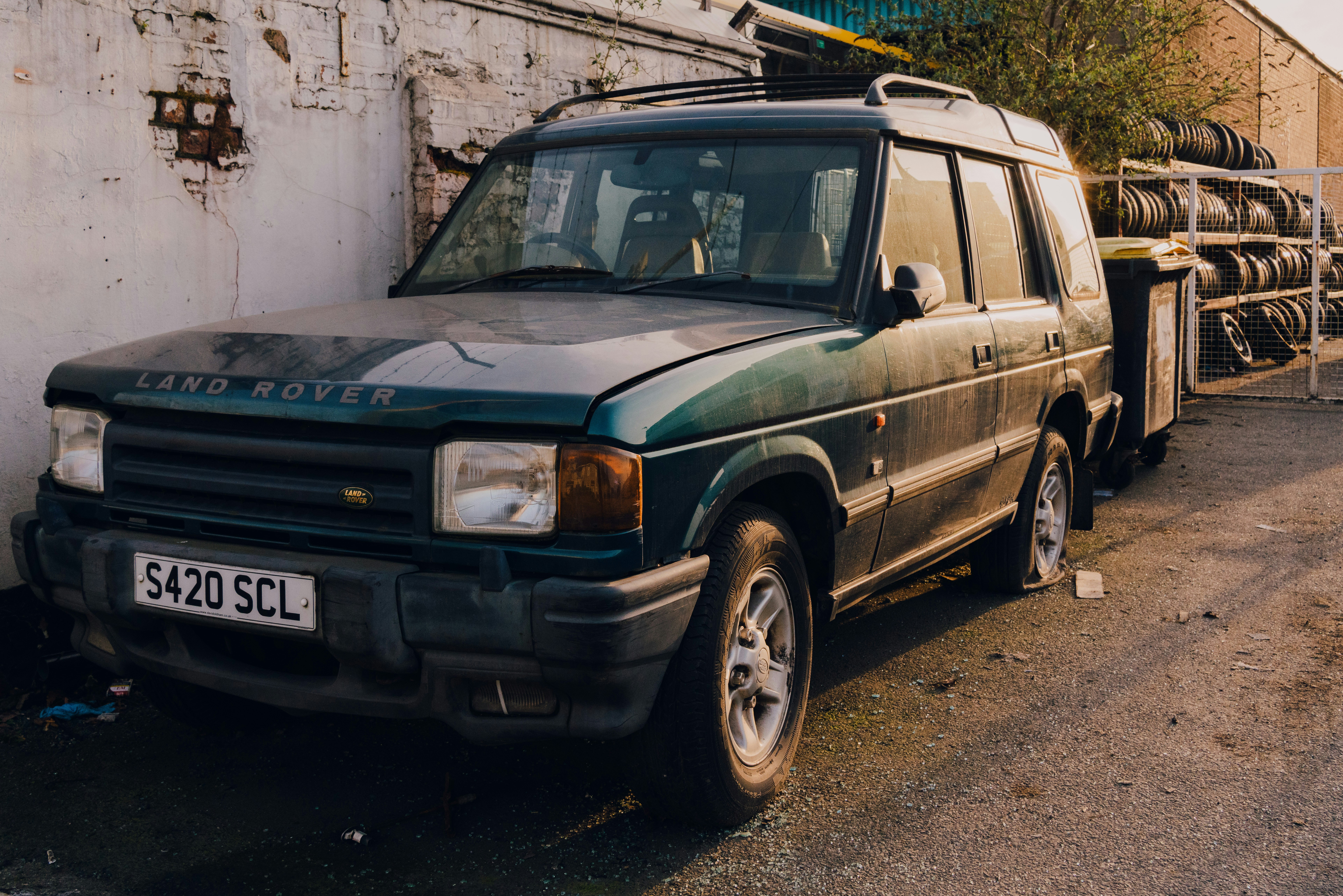 Weathered Land Rover Pickup in an Industrial Yard