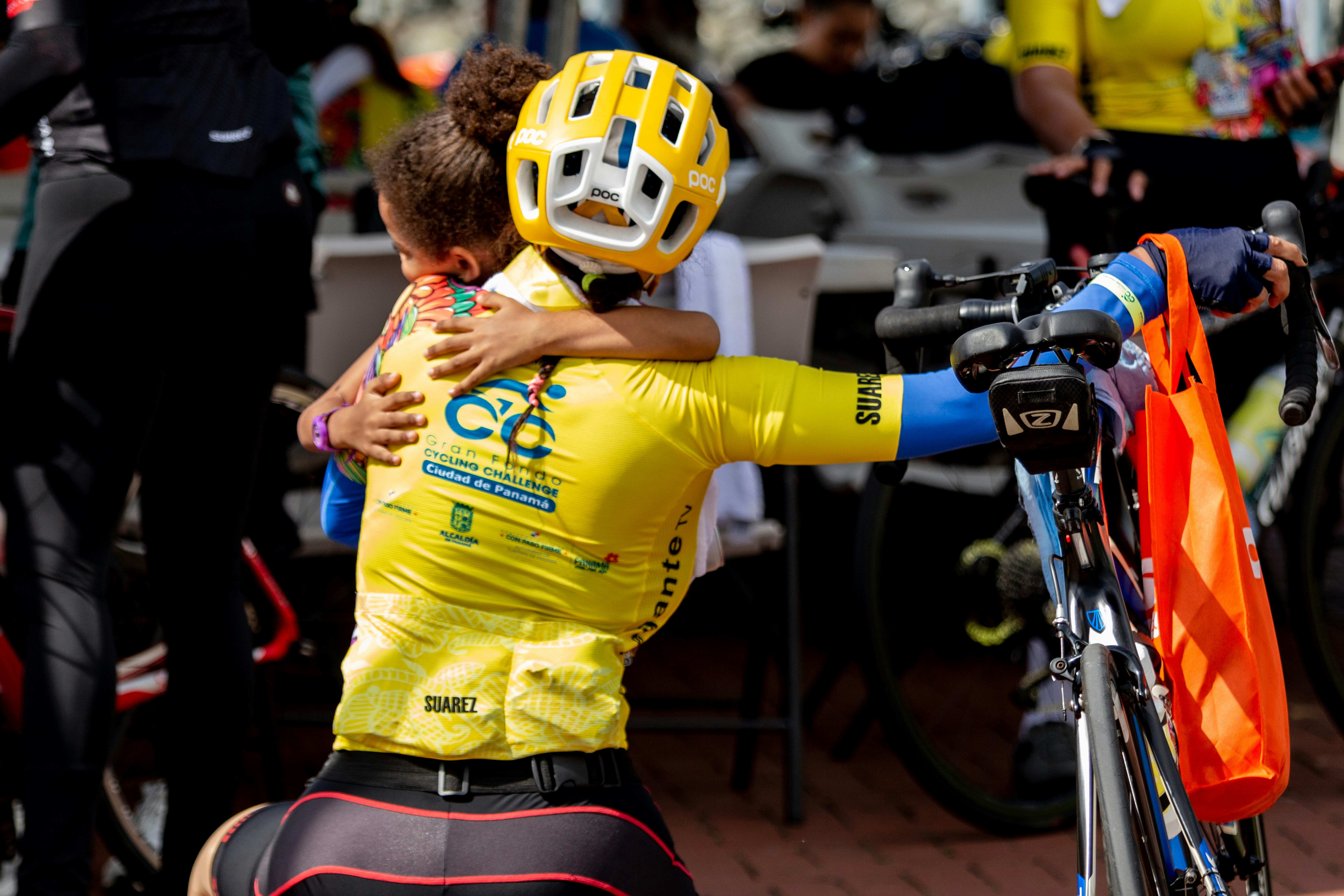 Two Cyclists Embrace After a Race Finish
