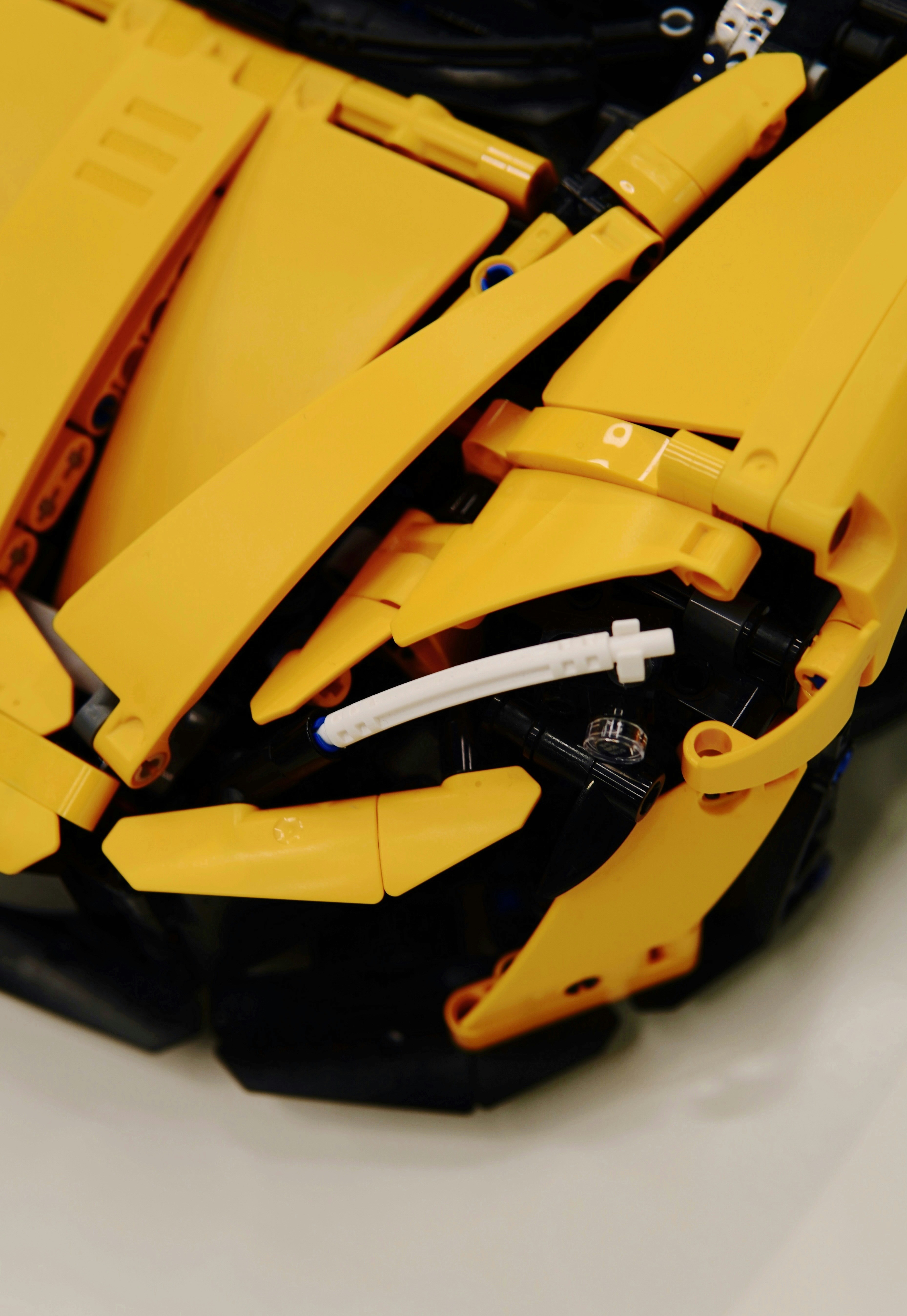 A yellow lego car is partially assembled. photo – Free Wallpaper Image ...