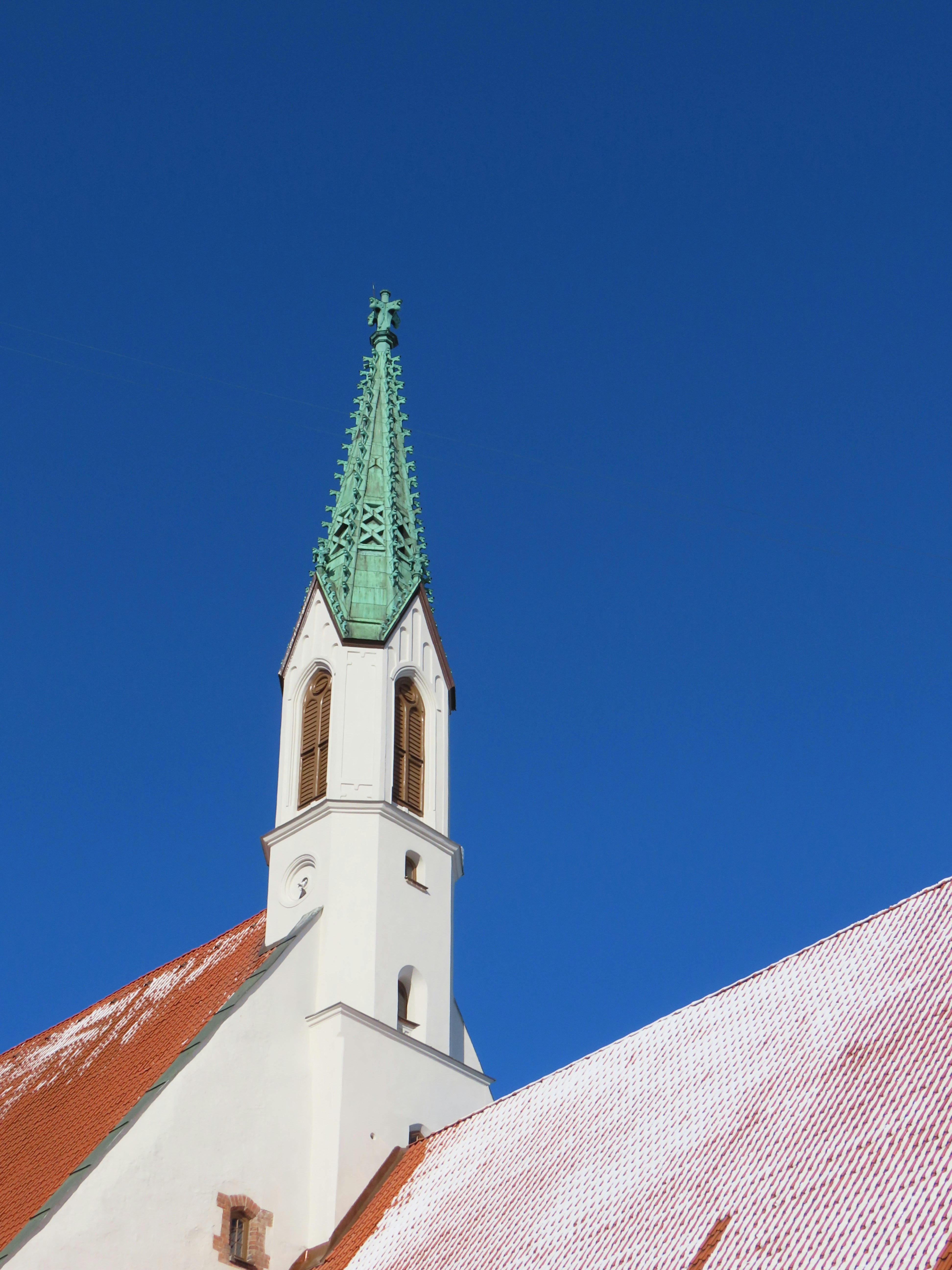 Verdigris Spire Against Azure: A Gothic Roof Reaches Skyward