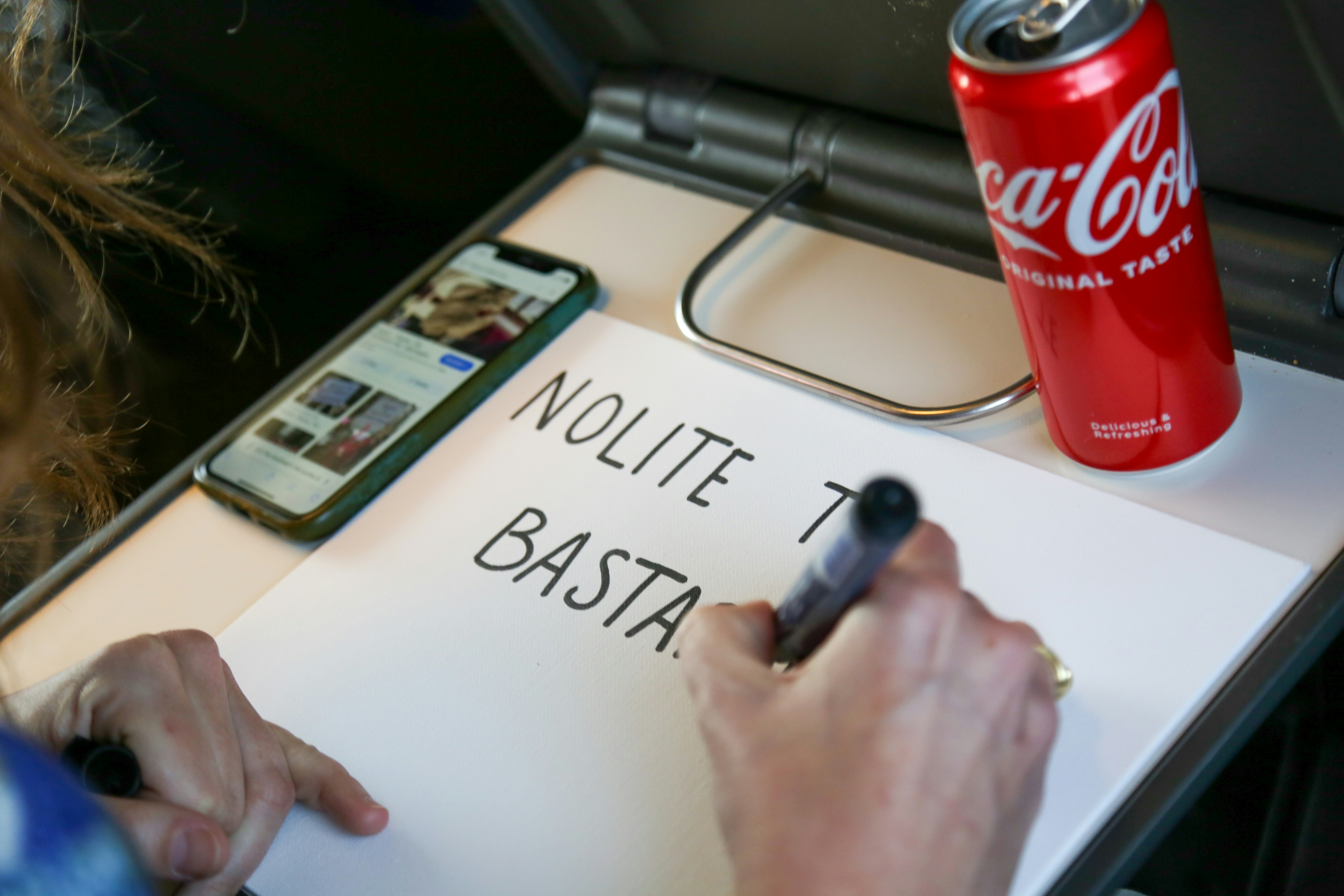 A person writes with a coke and a phone. photo – Free Woman Image on ...