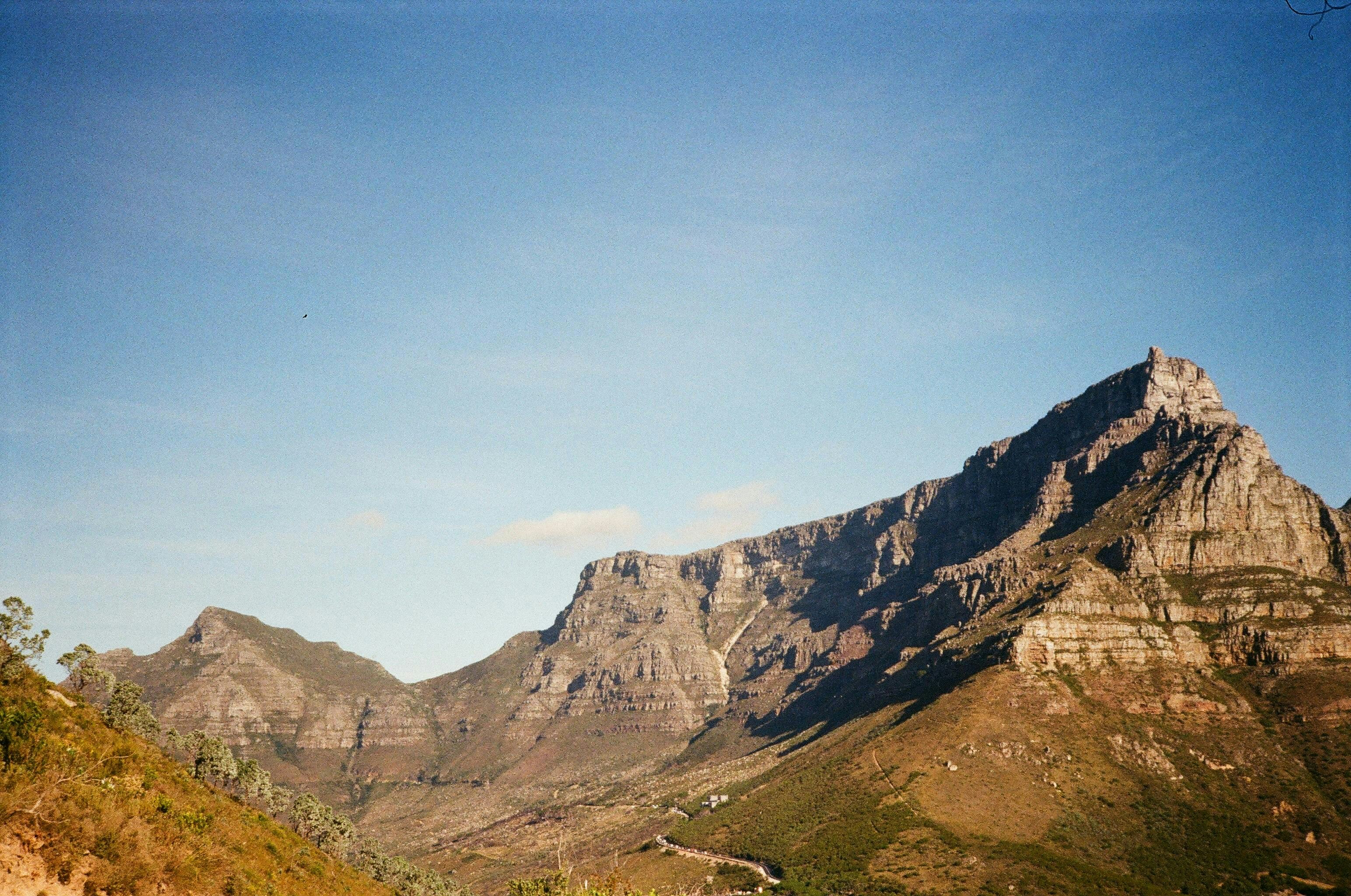 Mountains stand majestic underneath a bright sky. photo – Free Film ...