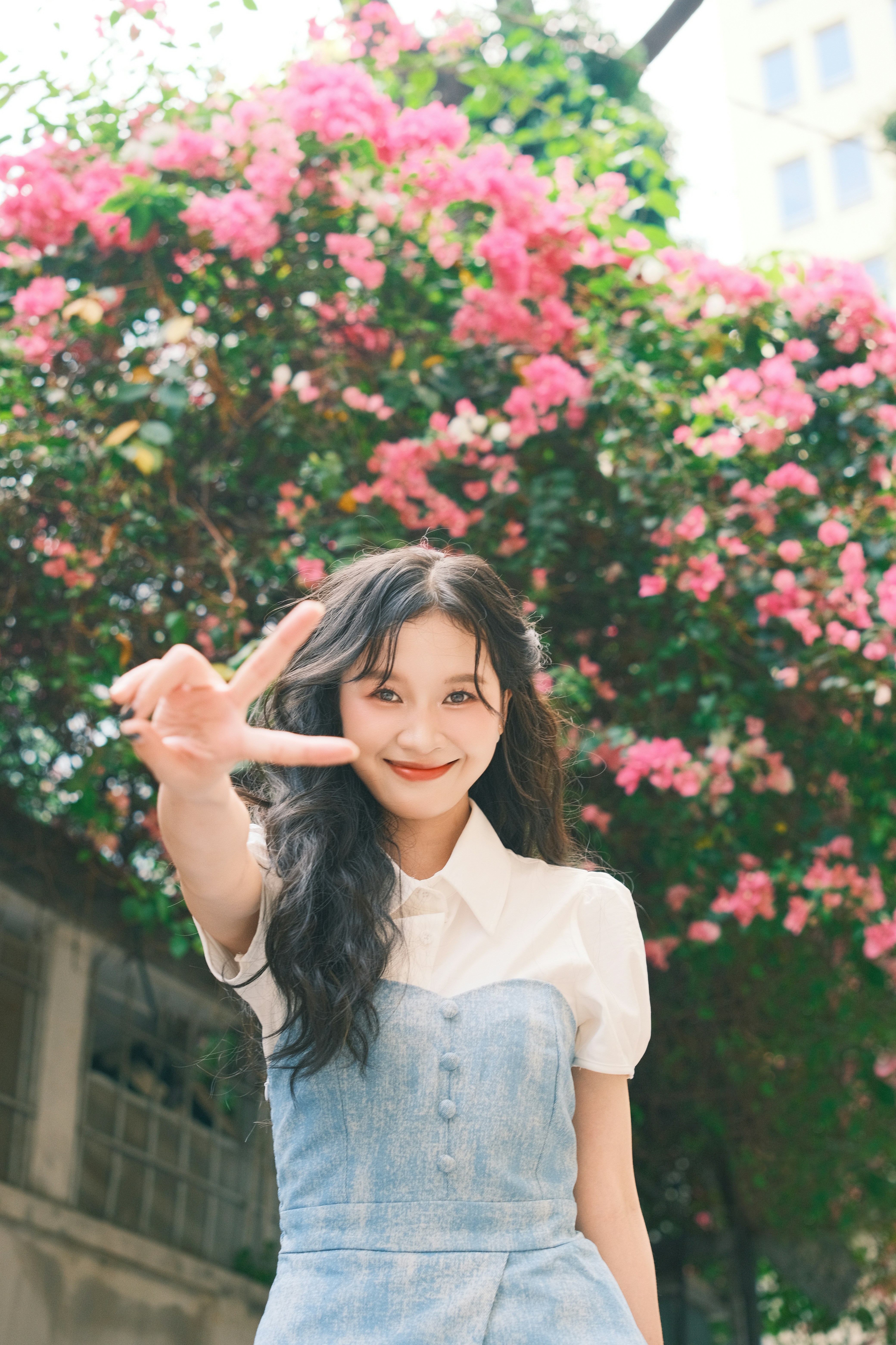 Pretty girl poses in front of flowering bushes. photo – Free Portrait ...