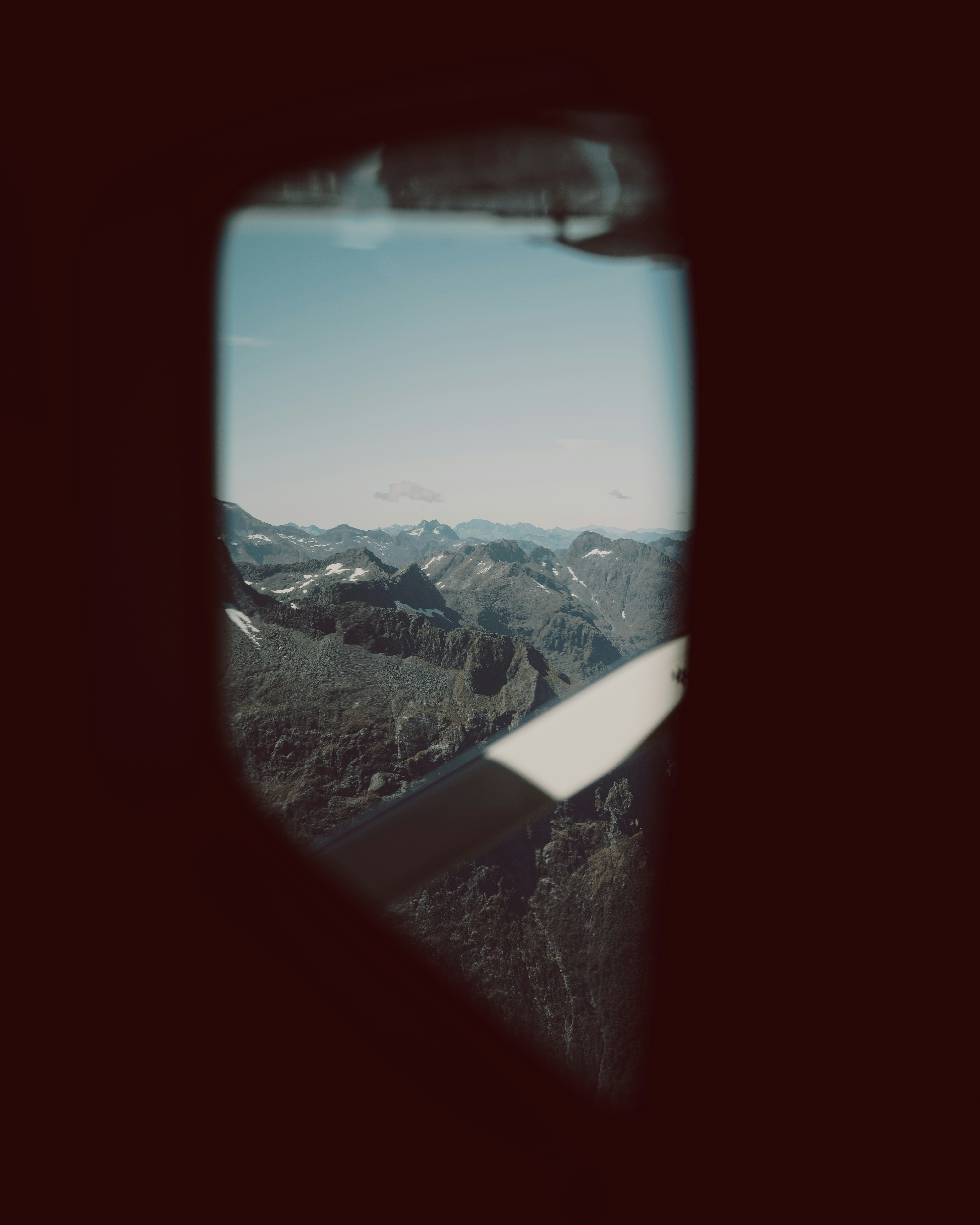 Alpine panorama framed by a cockpit window