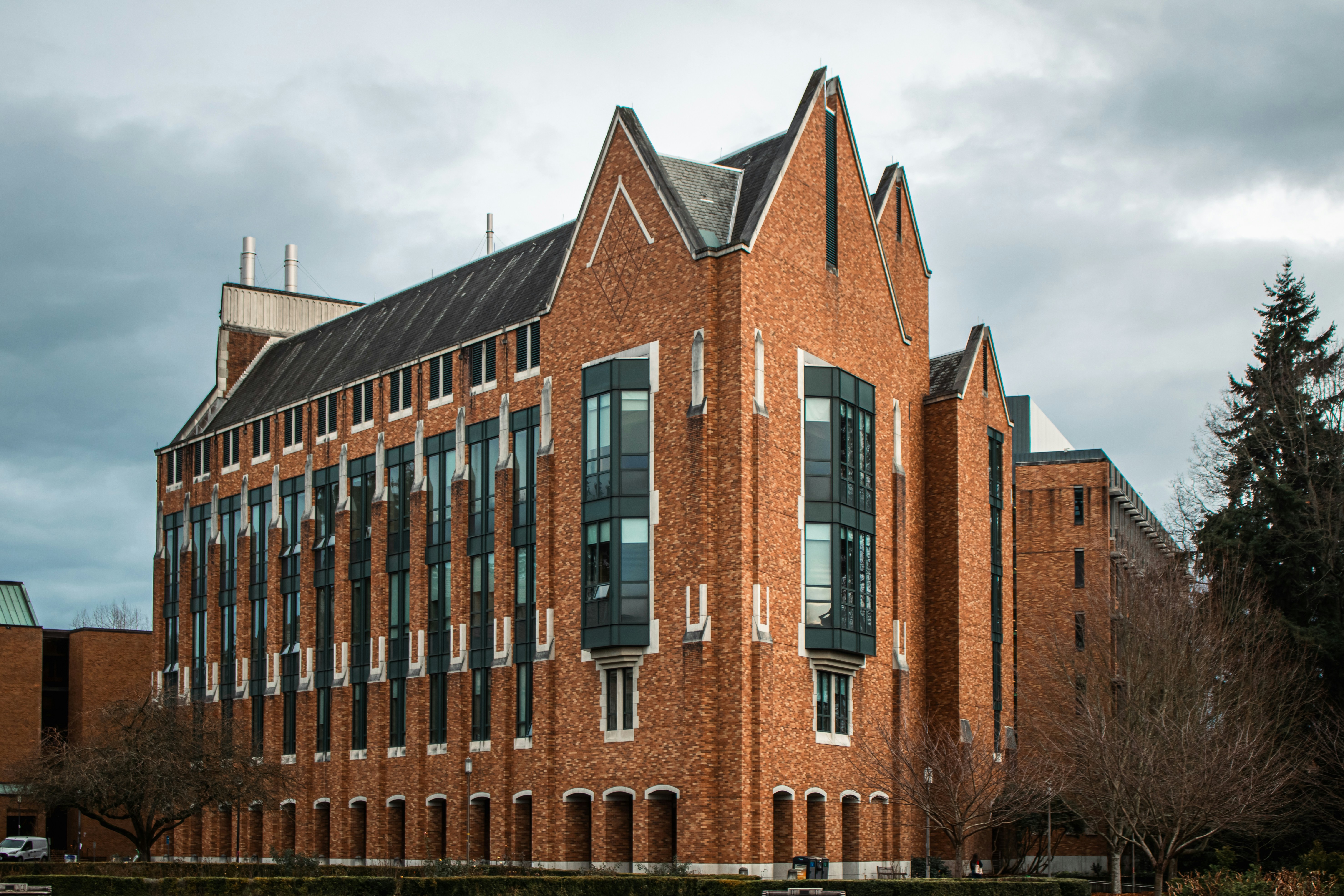 A brick building with a unique gothic roof. photo – Free Building Image ...