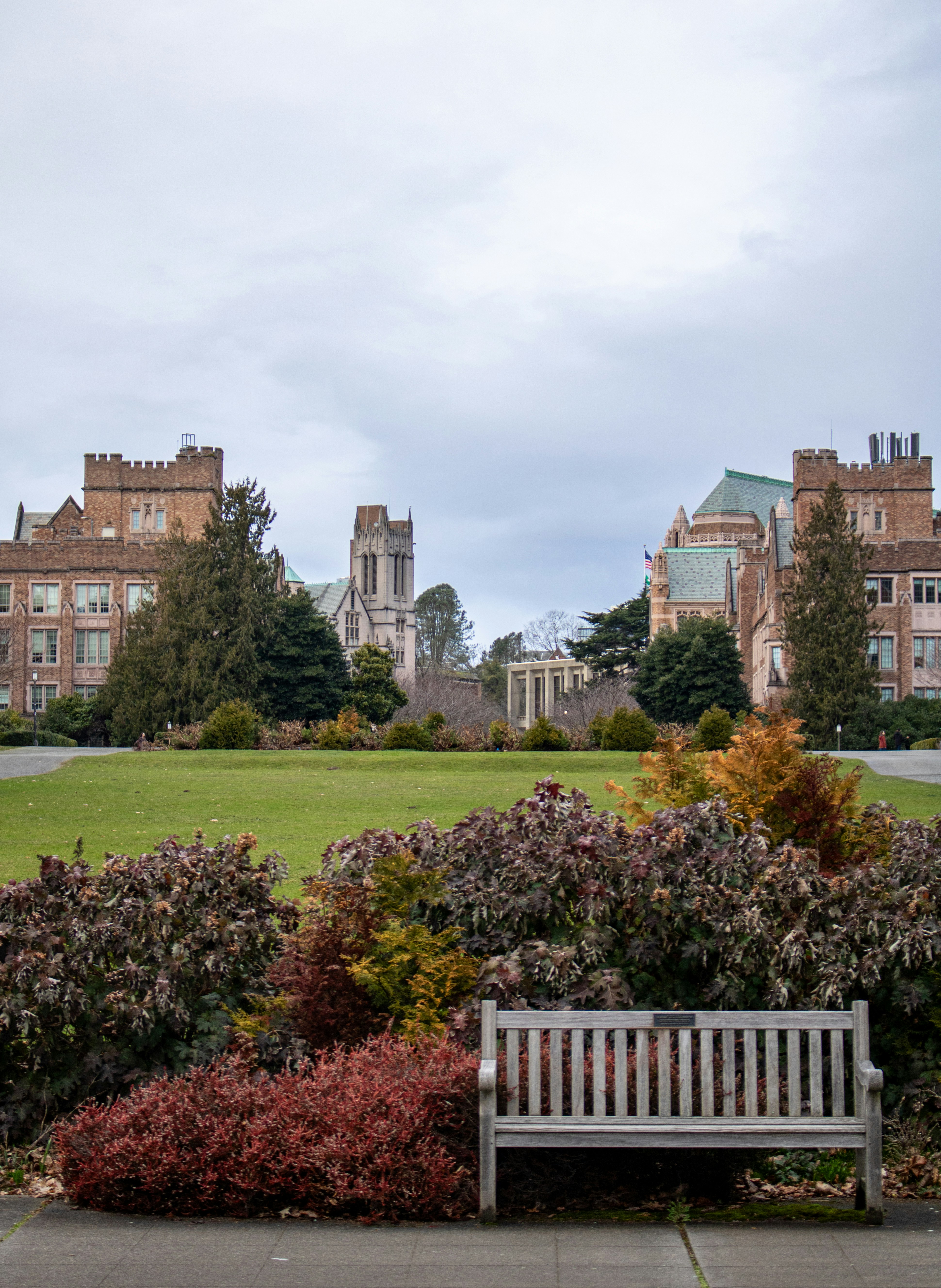 Autumn Benchscape: Quiet Campus Amid Brick Towers