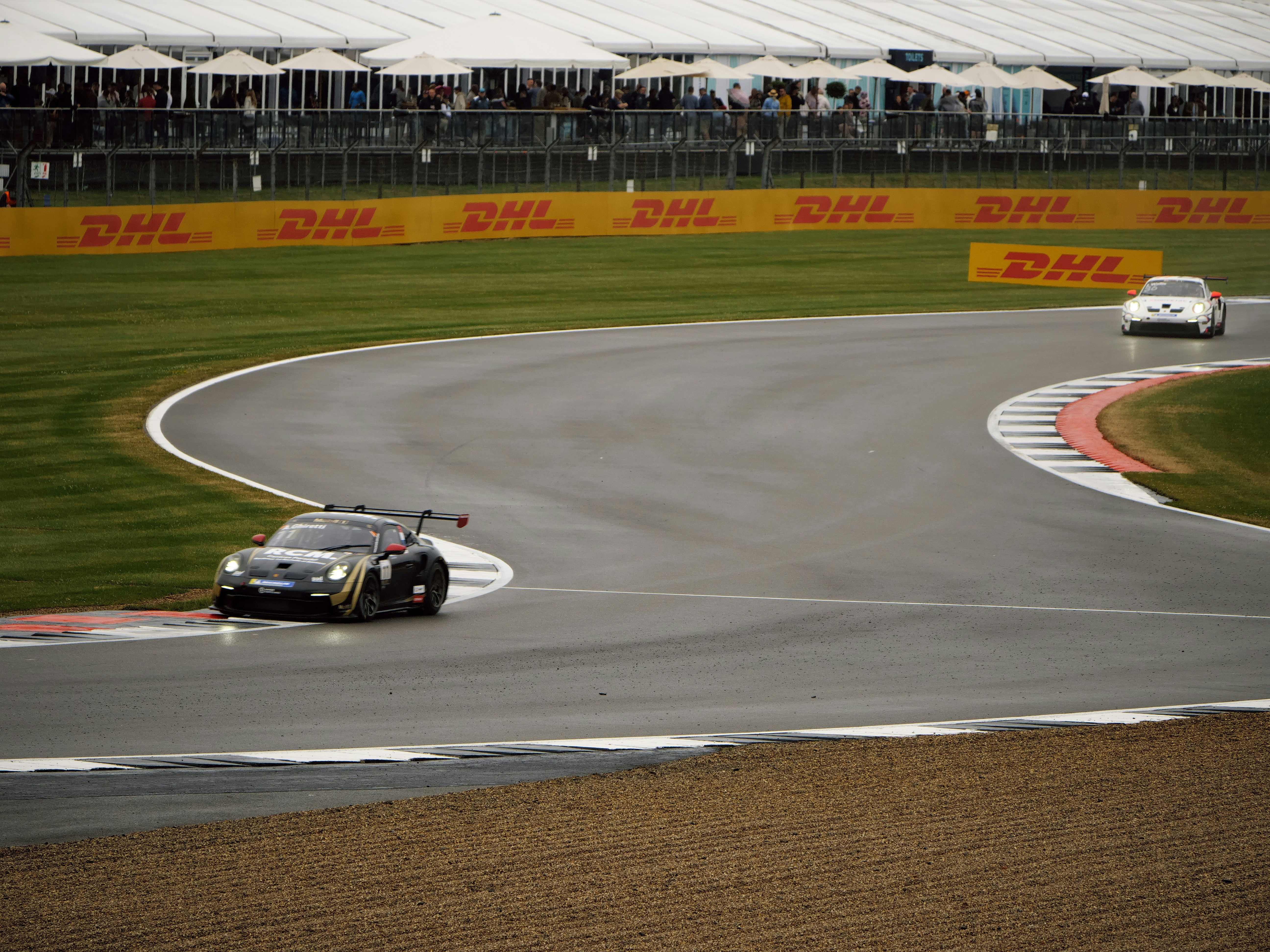 Cars racing on a curved track at a motor race. photo – Free Car Image ...