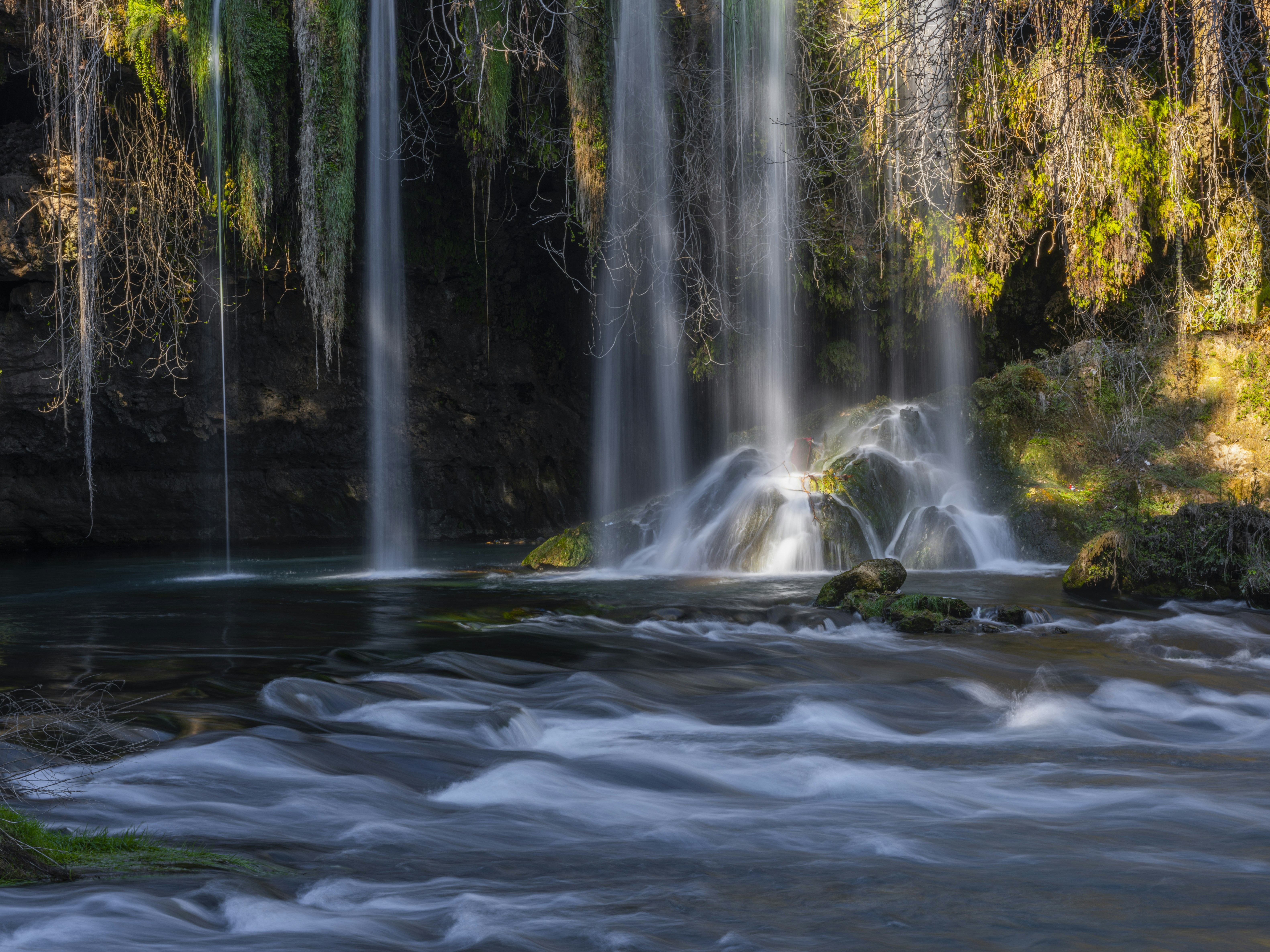 A beautiful waterfall cascades into a calm river. photo – Free Forest ...