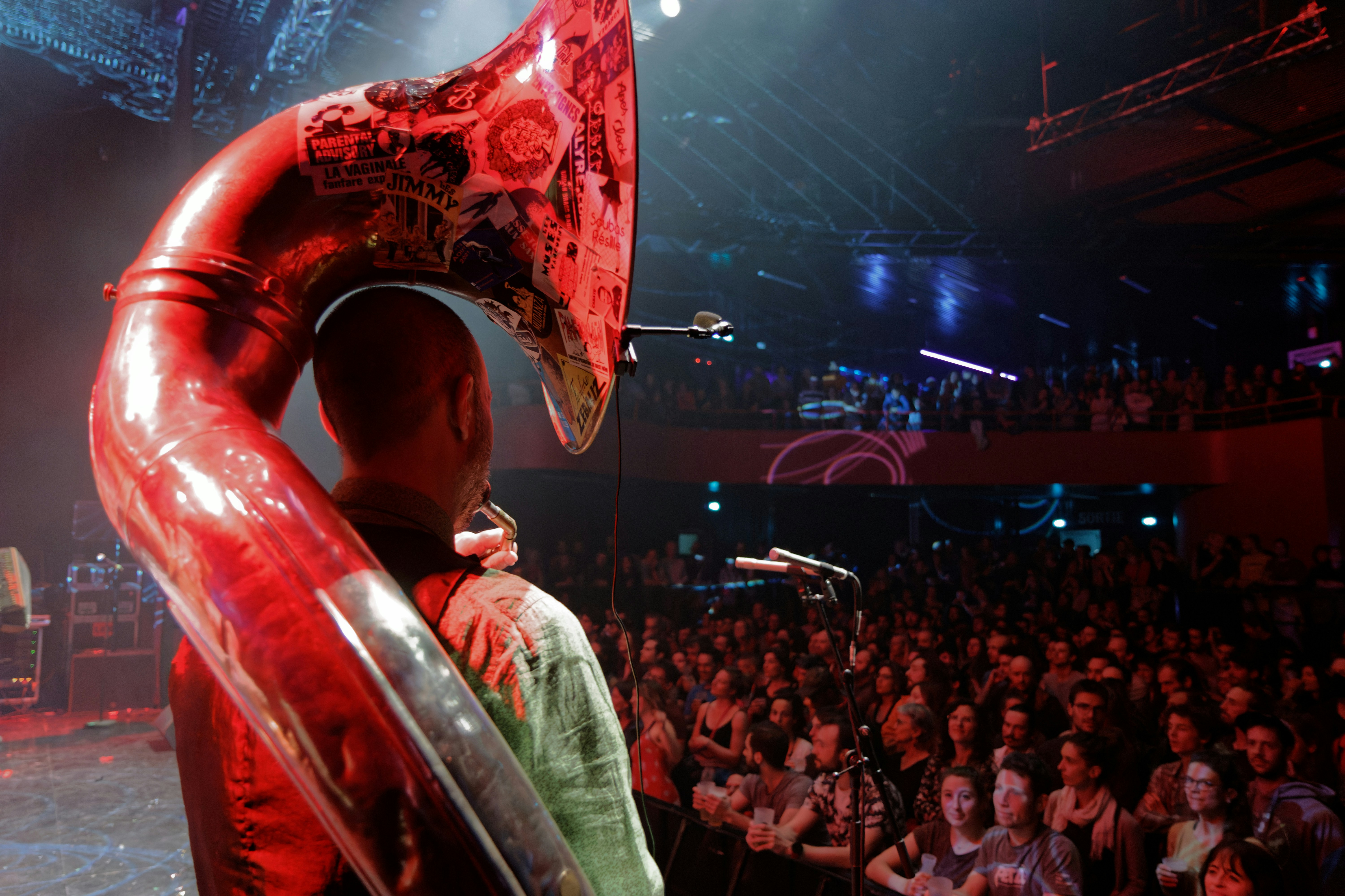 Musician plays tuba on stage in front of a crowd. photo – Free Concert ...