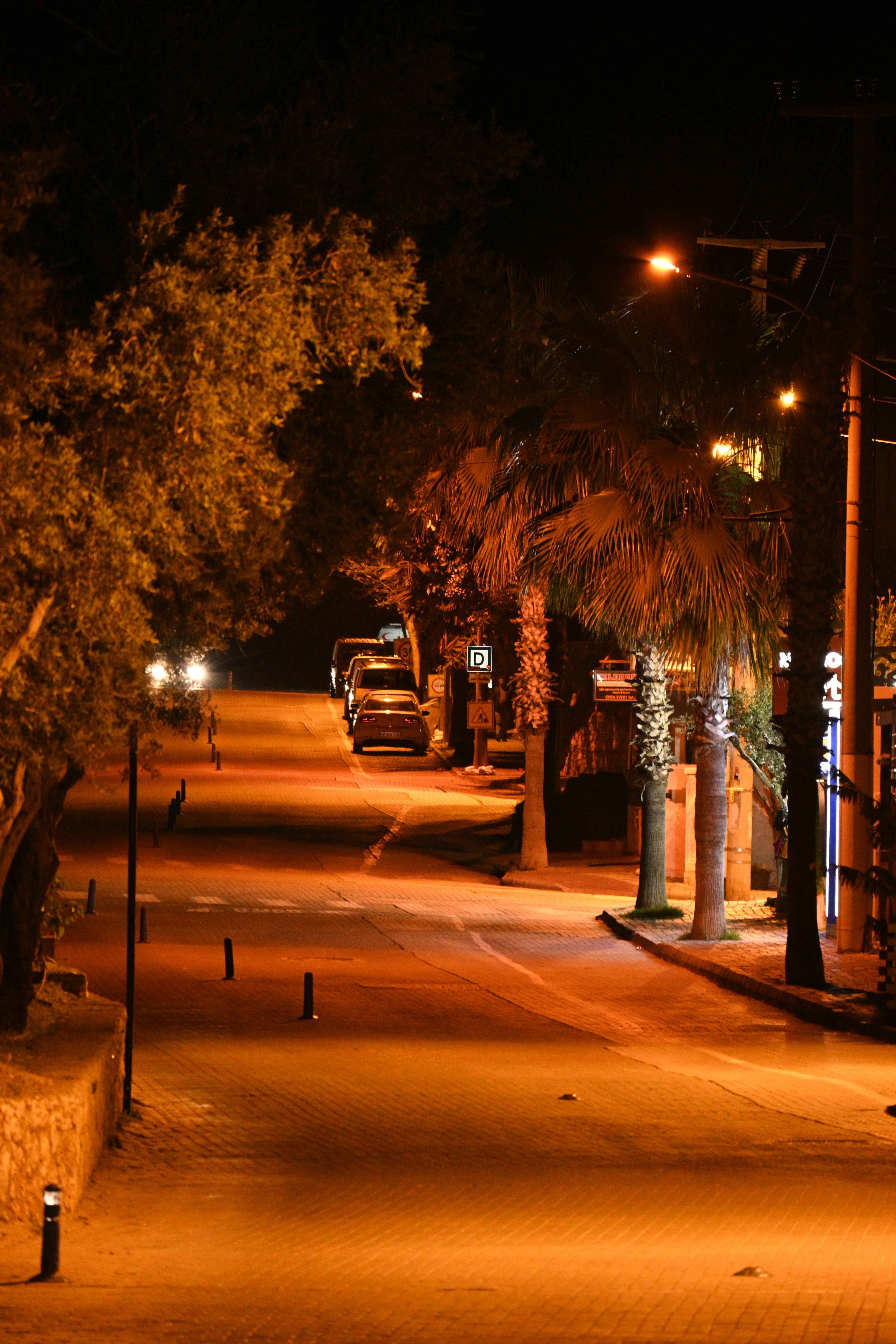 A dark street illuminated by warm street lights. photo – Free Night ...