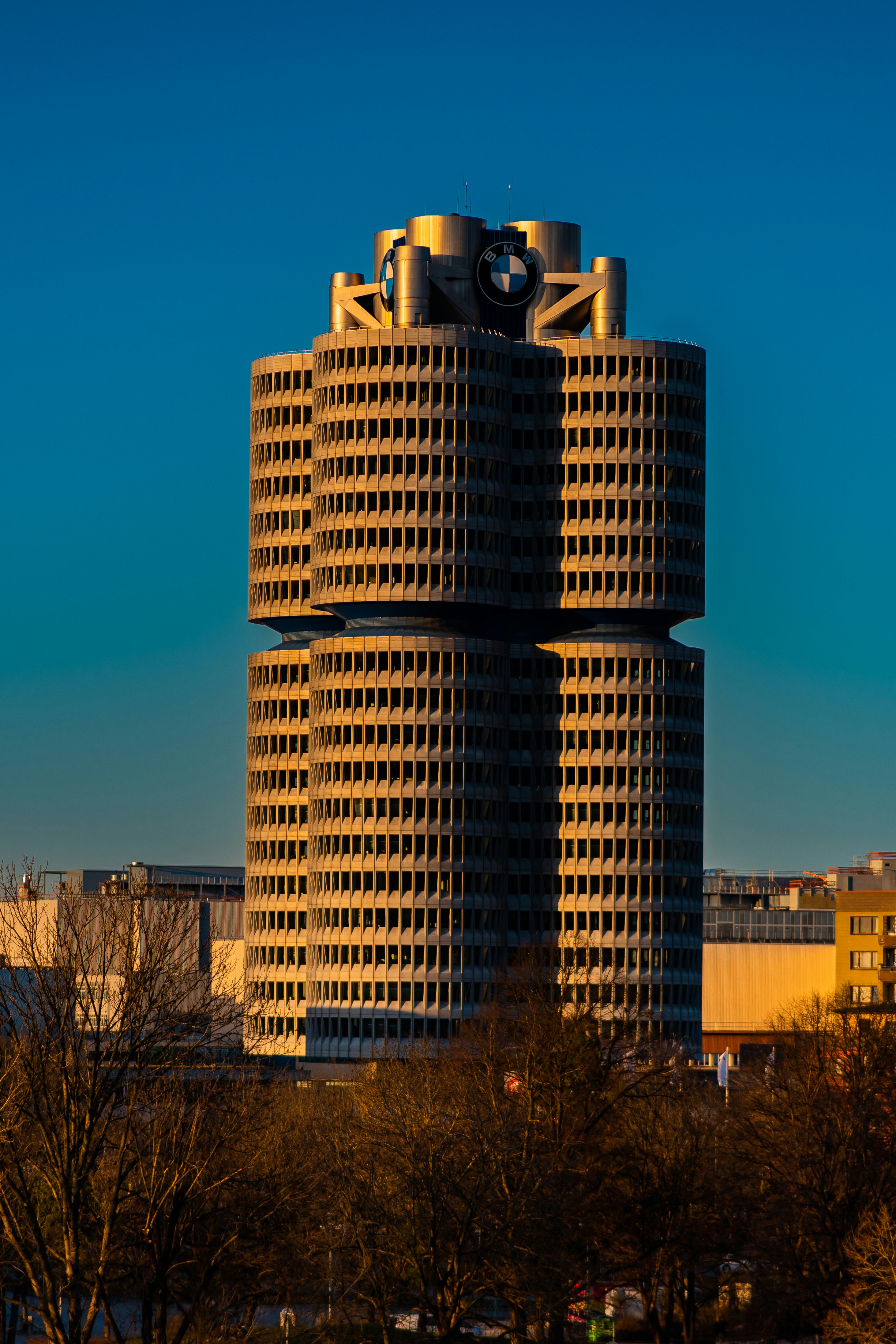 Gilded Cylinder: BMW Tower Basks in Low-Angle Sun