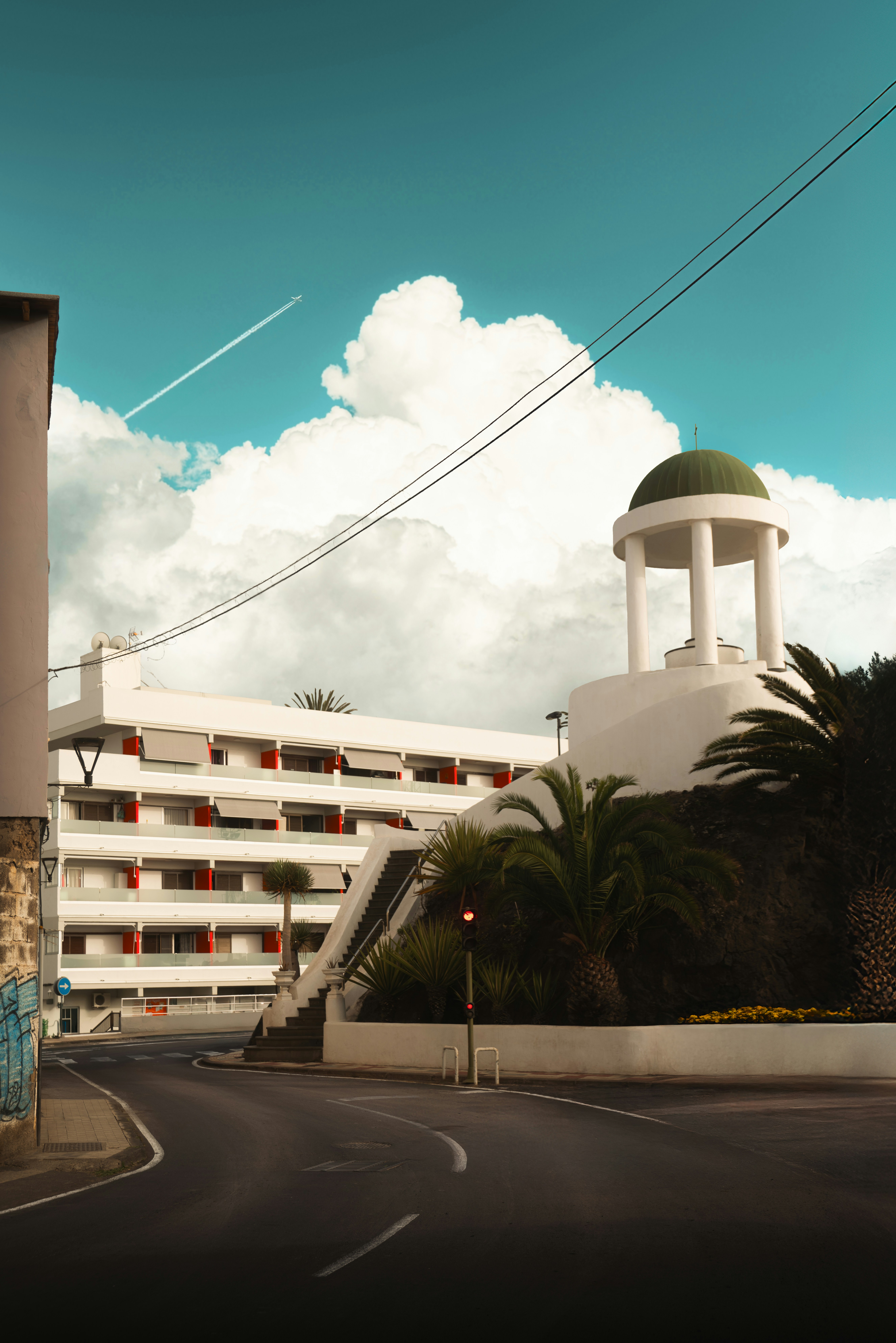 Green-Domed Pavilion Rising Over a Palm-Lined Resort Street