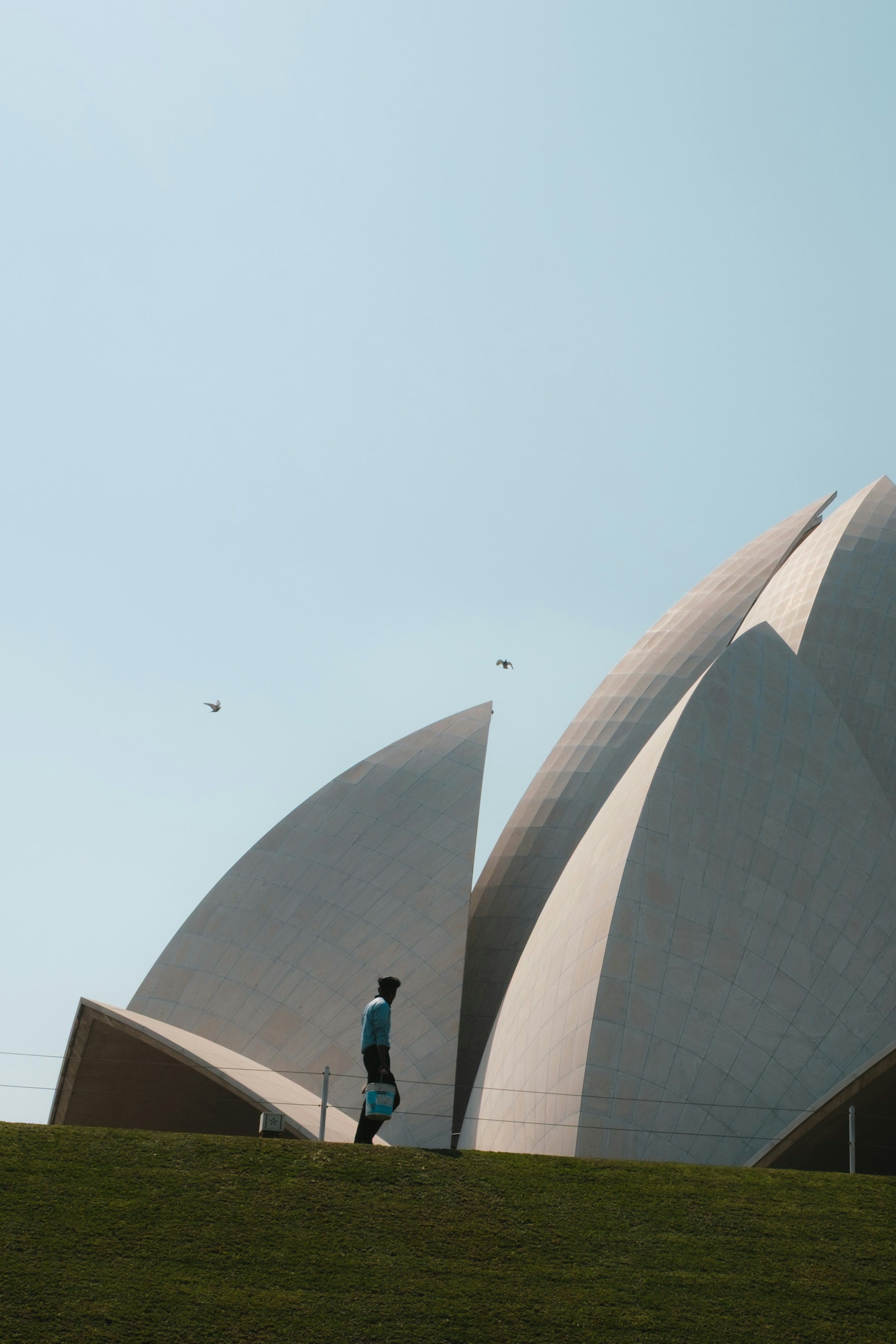 Silhouette Step: A lone figure against the curved sails