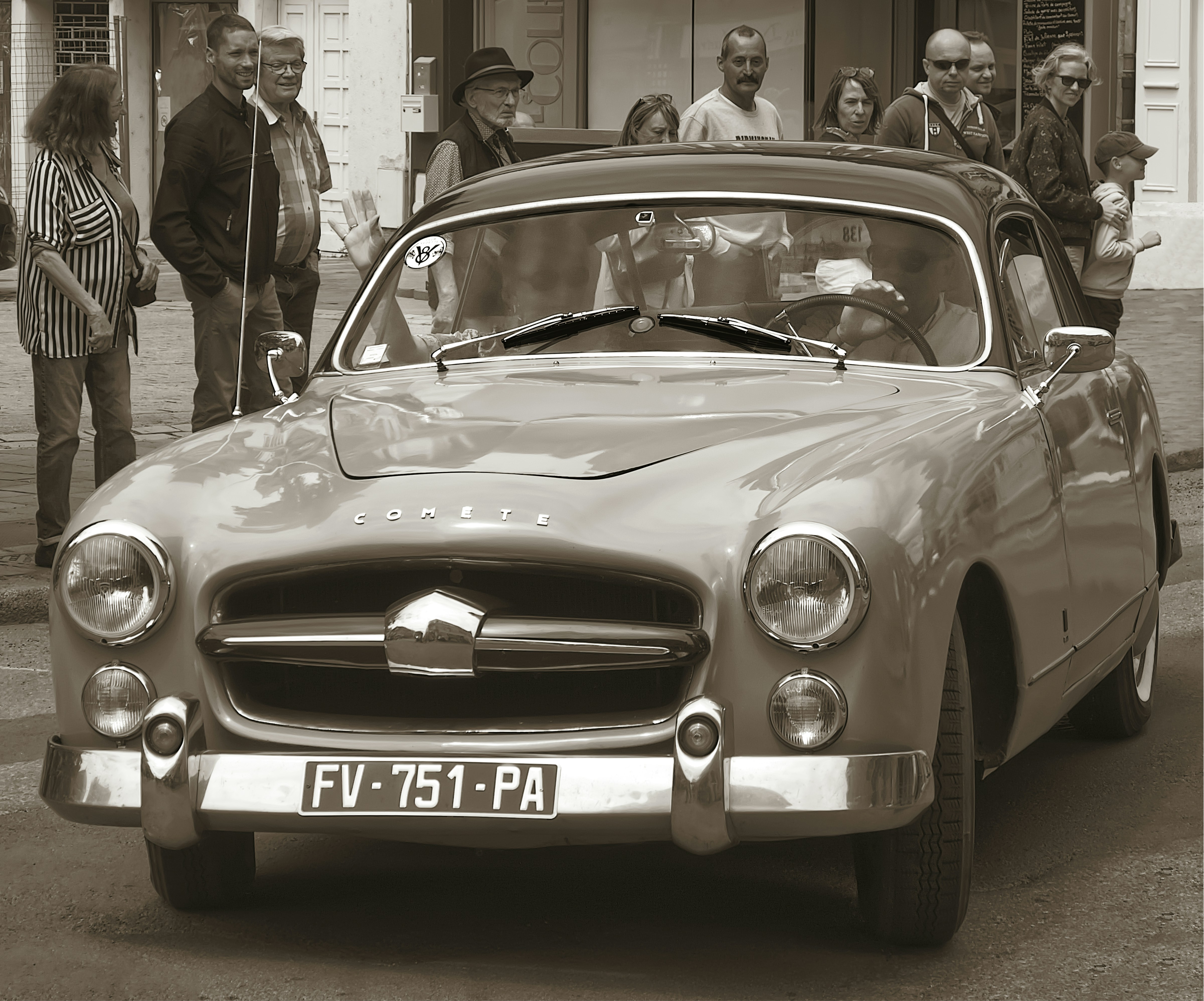Front-Row Chrome: A 1950s Classic Anchors a Curious Street Gathering