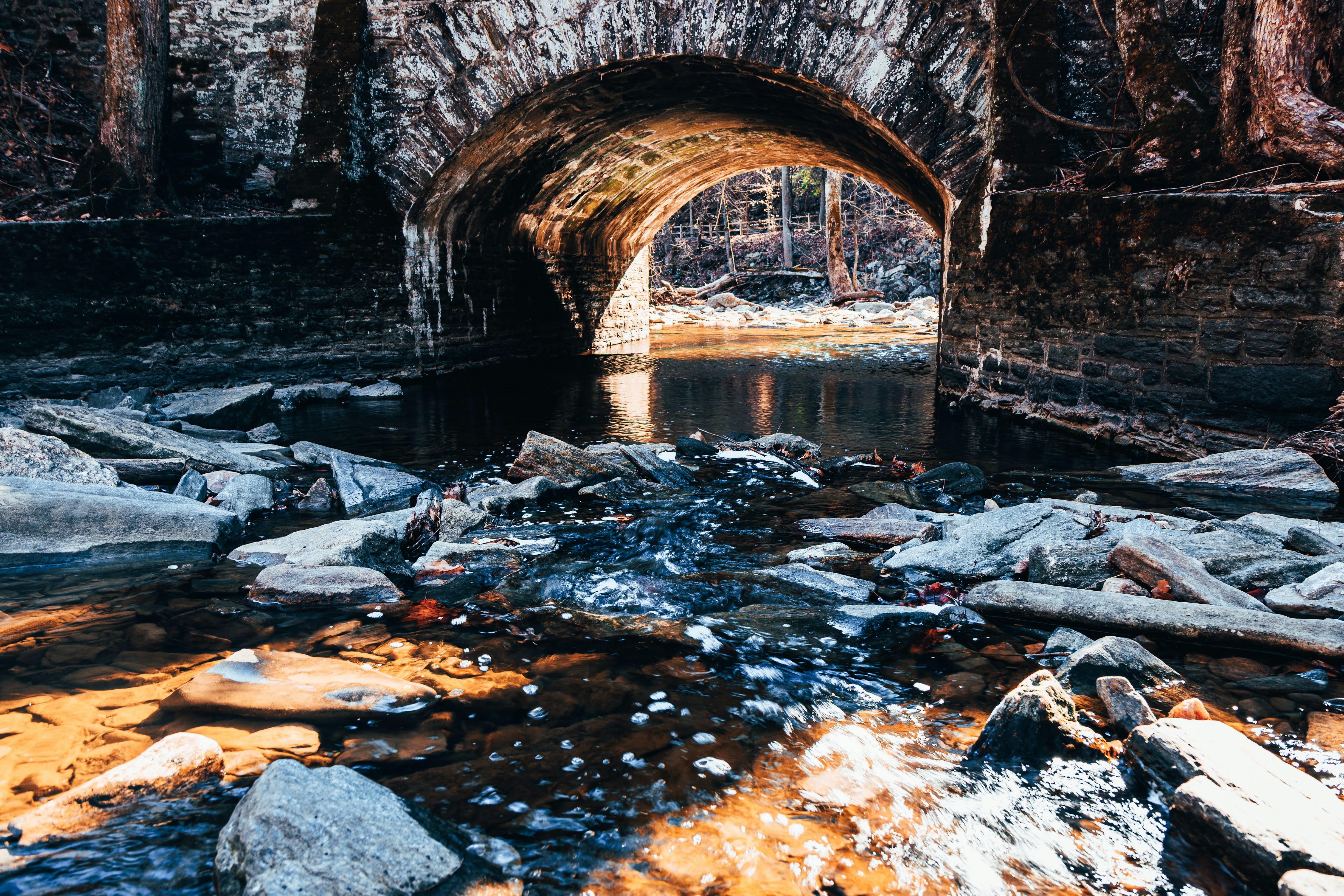 Sunlit Archway Beneath an Ancient Stone Bridge