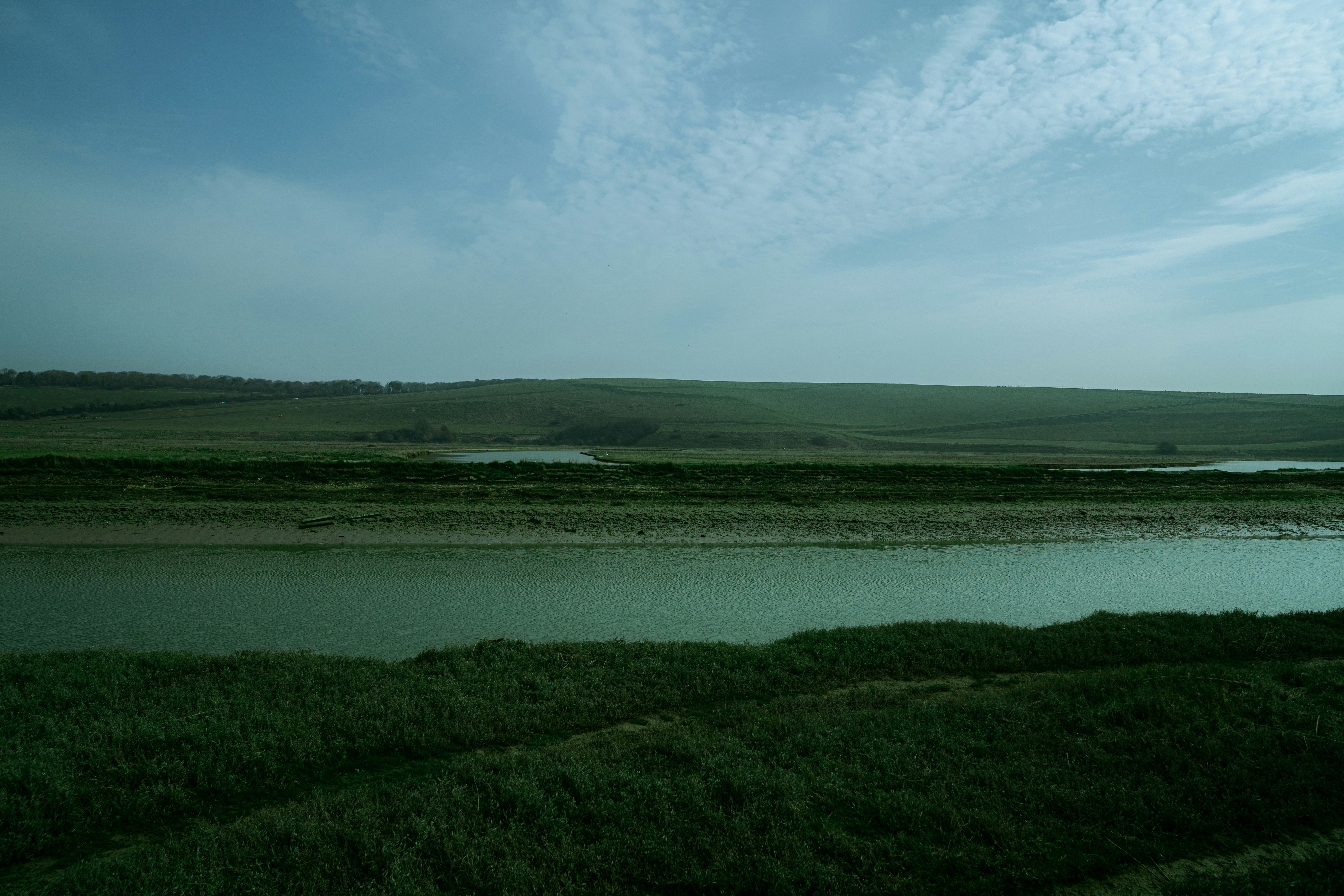 A river flows through a lush green landscape. photo – Free Land Image ...