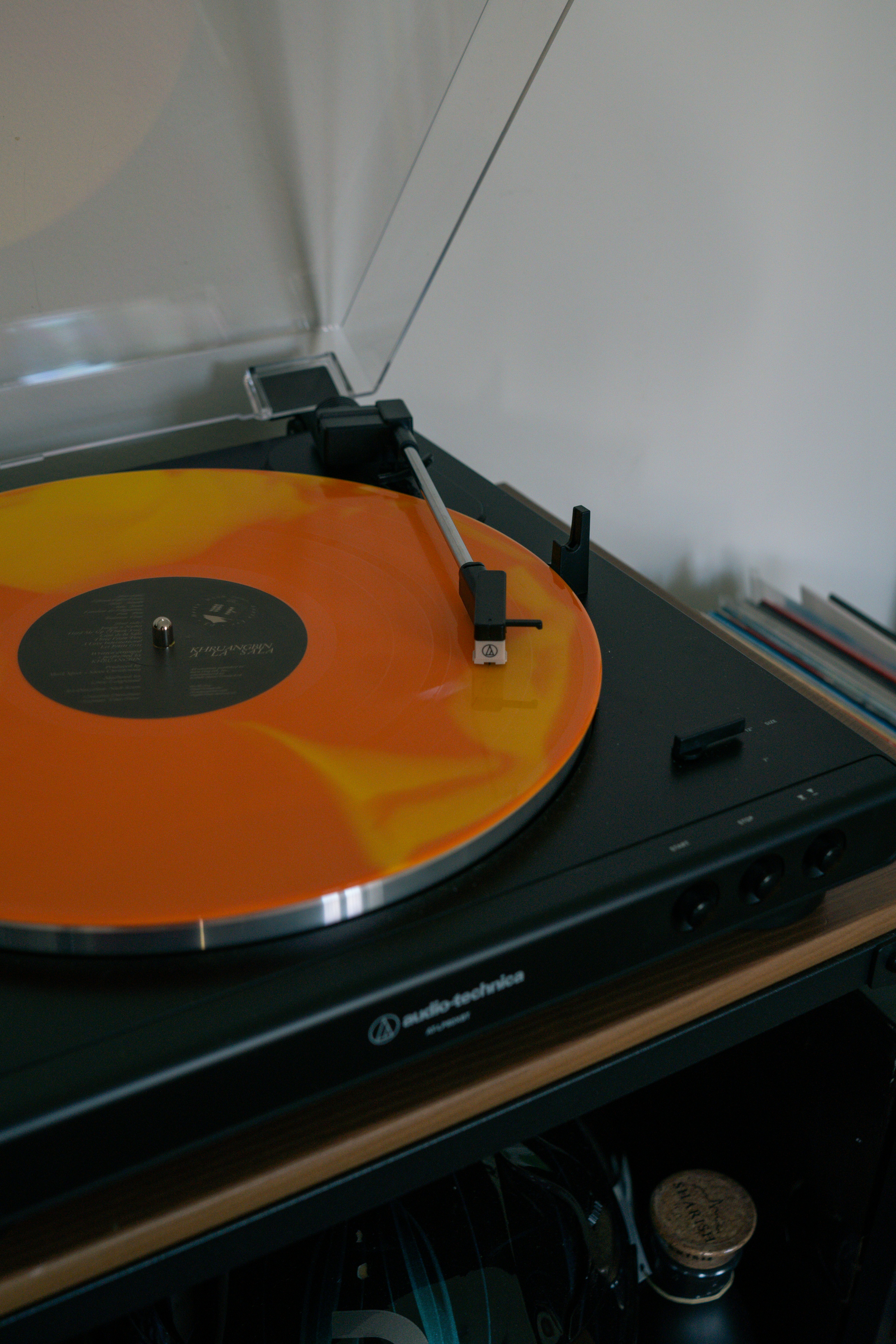 Glow on the Groove: Orange Vinyl Under a Clear Lid