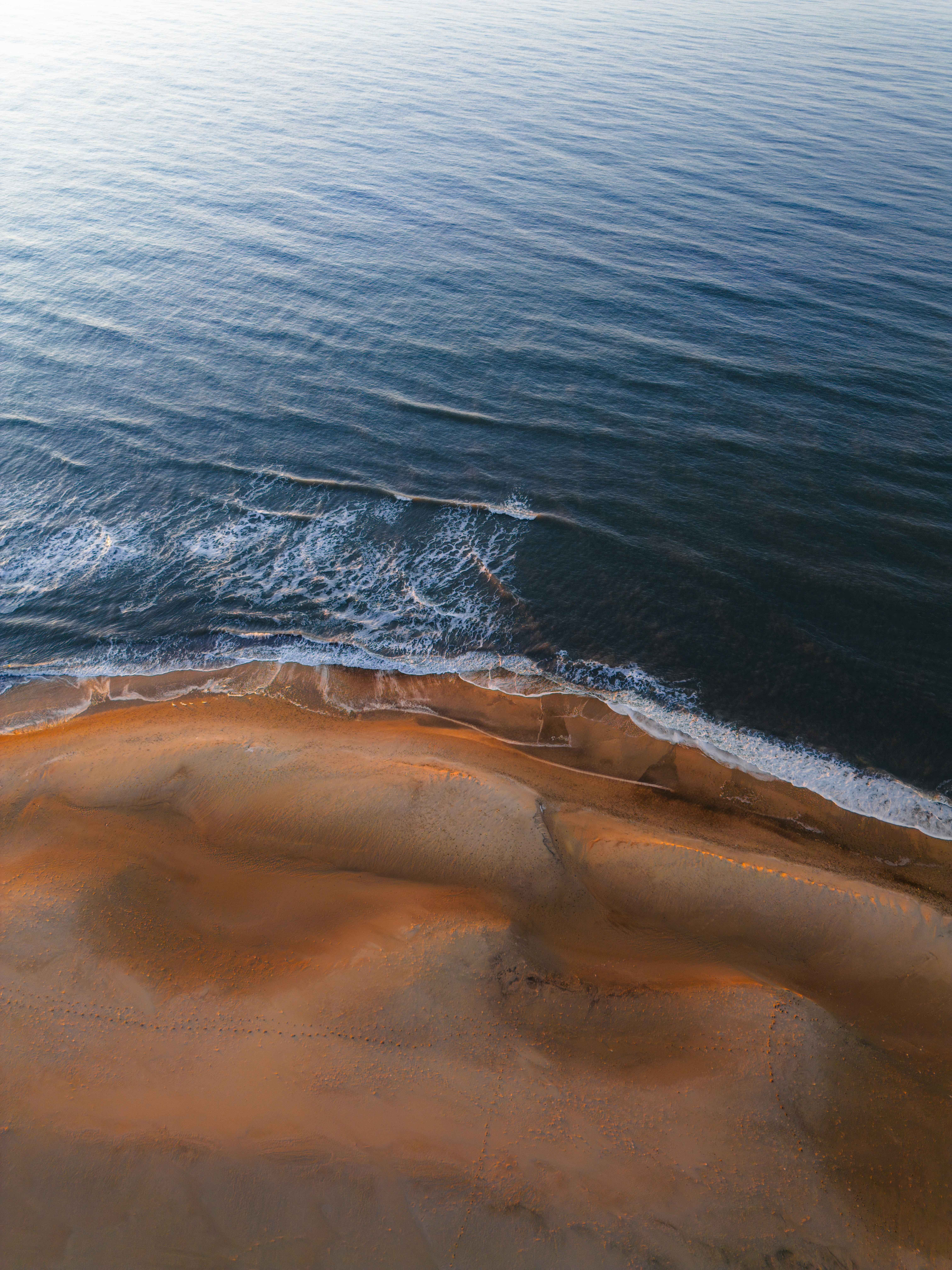 Aerial view of the ocean meeting the beach. photo – Free Beach Image on ...