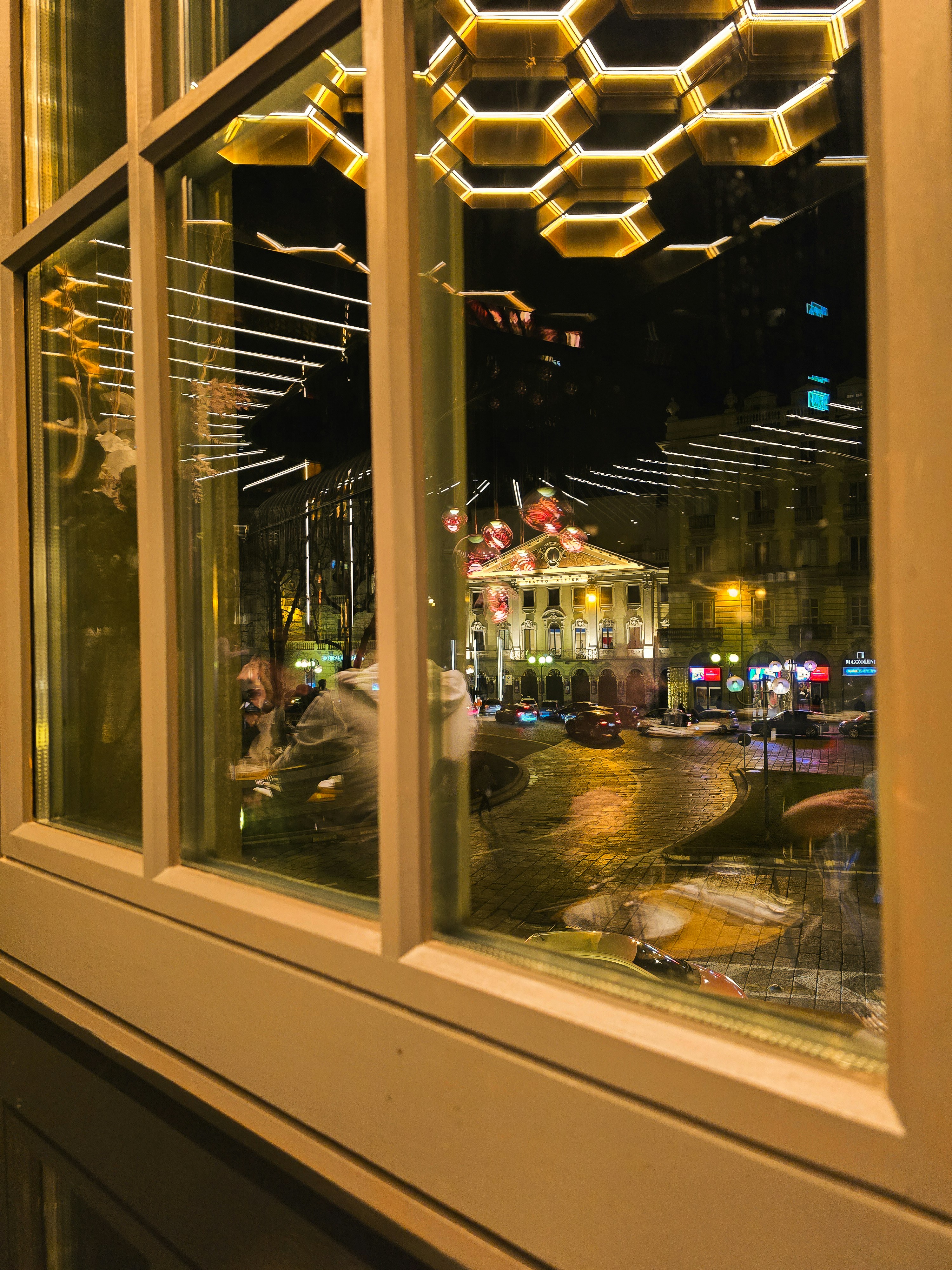 Hexagonal Glow Framing a Rain-Washed City Street